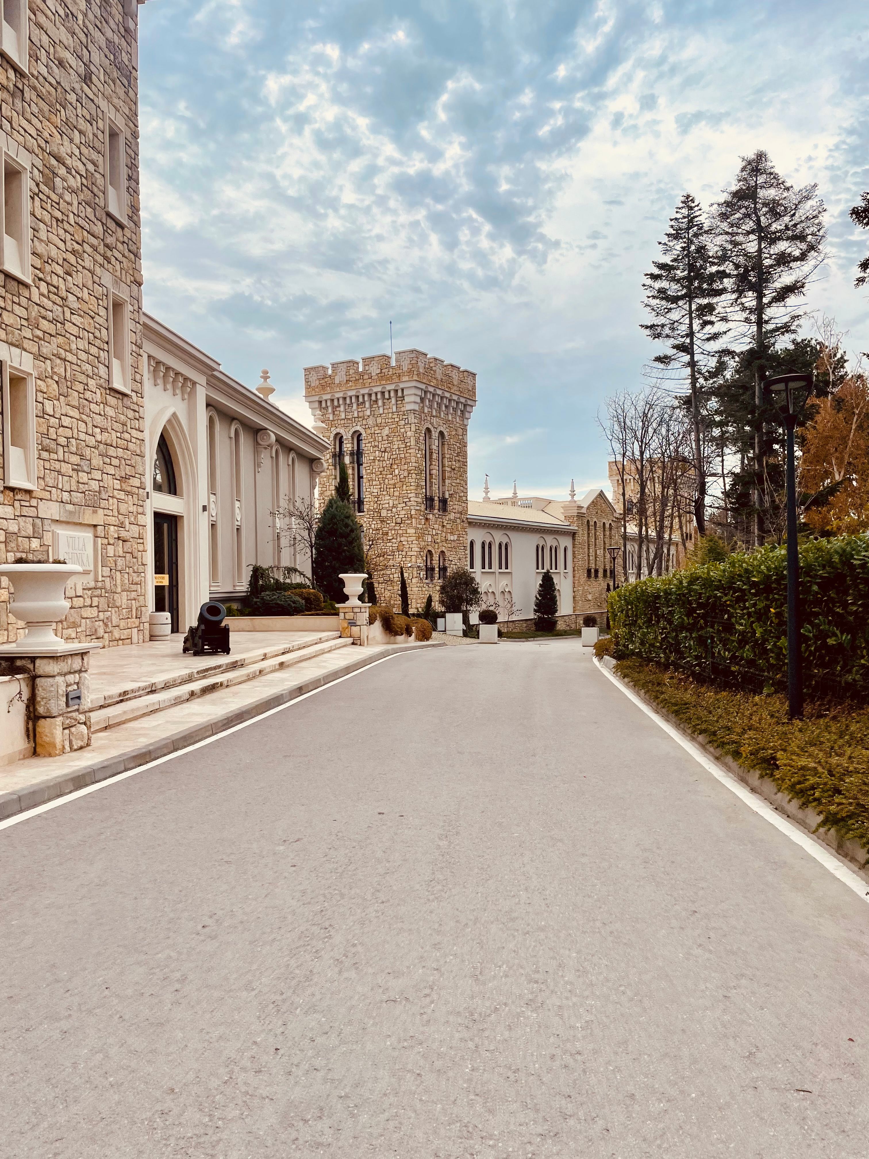 Stone Castle-Like Building with Tower and Sky View · Free Stock Photo
