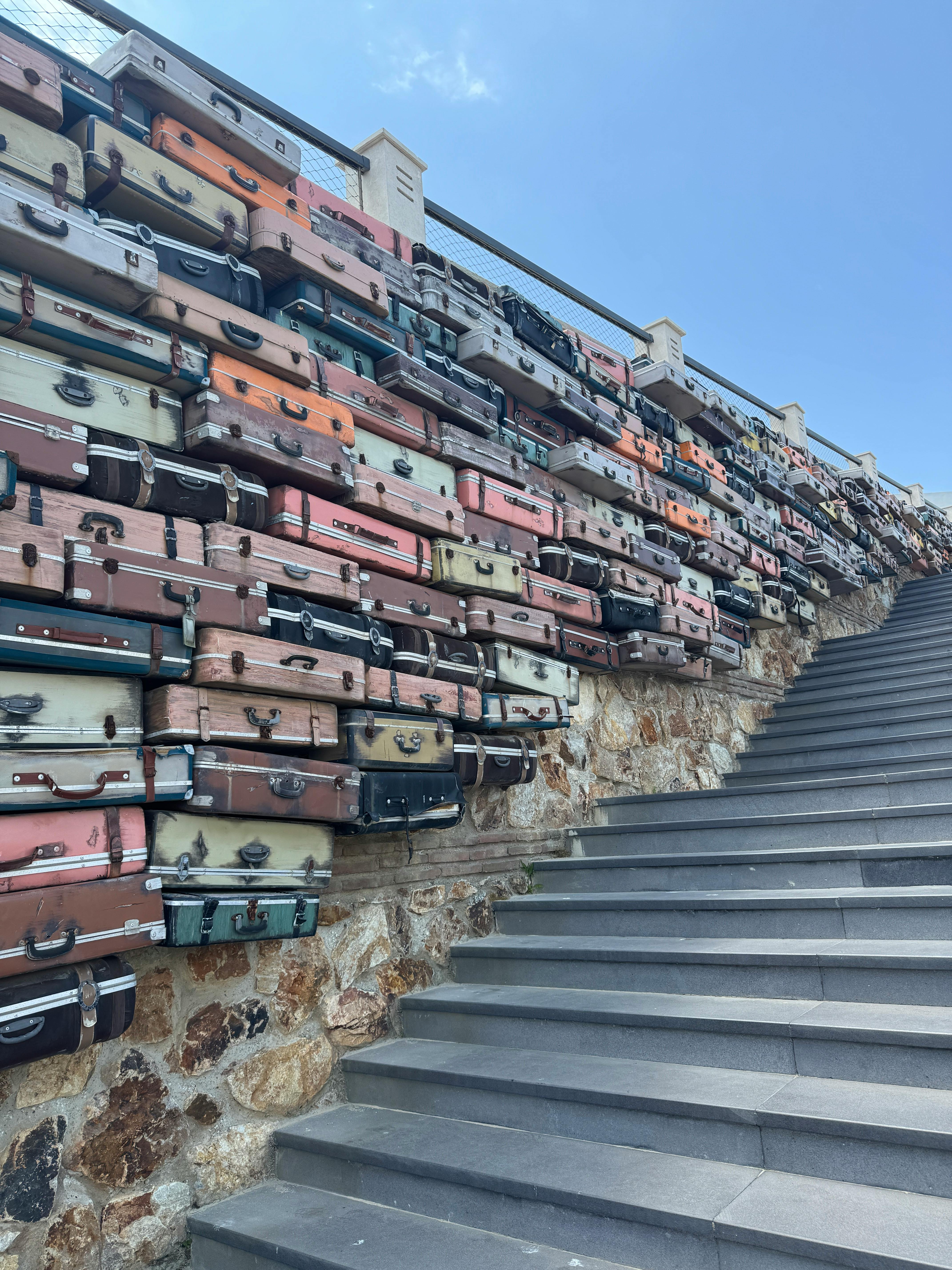 Colorful Suitcase Wall on Outdoor Staircase · Free Stock Photo