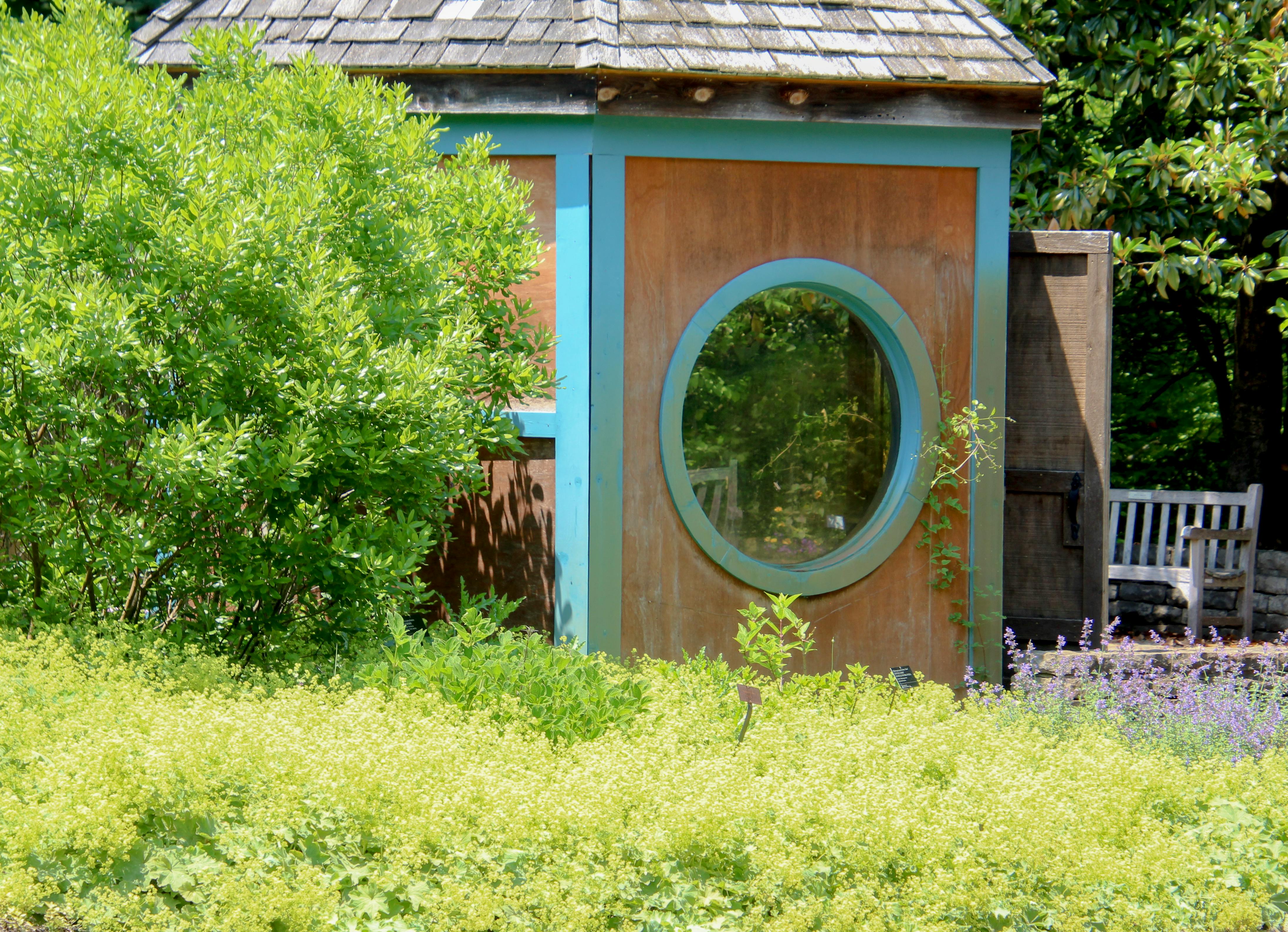 Cozy Garden Shed with Circular Window · Free Stock Photo