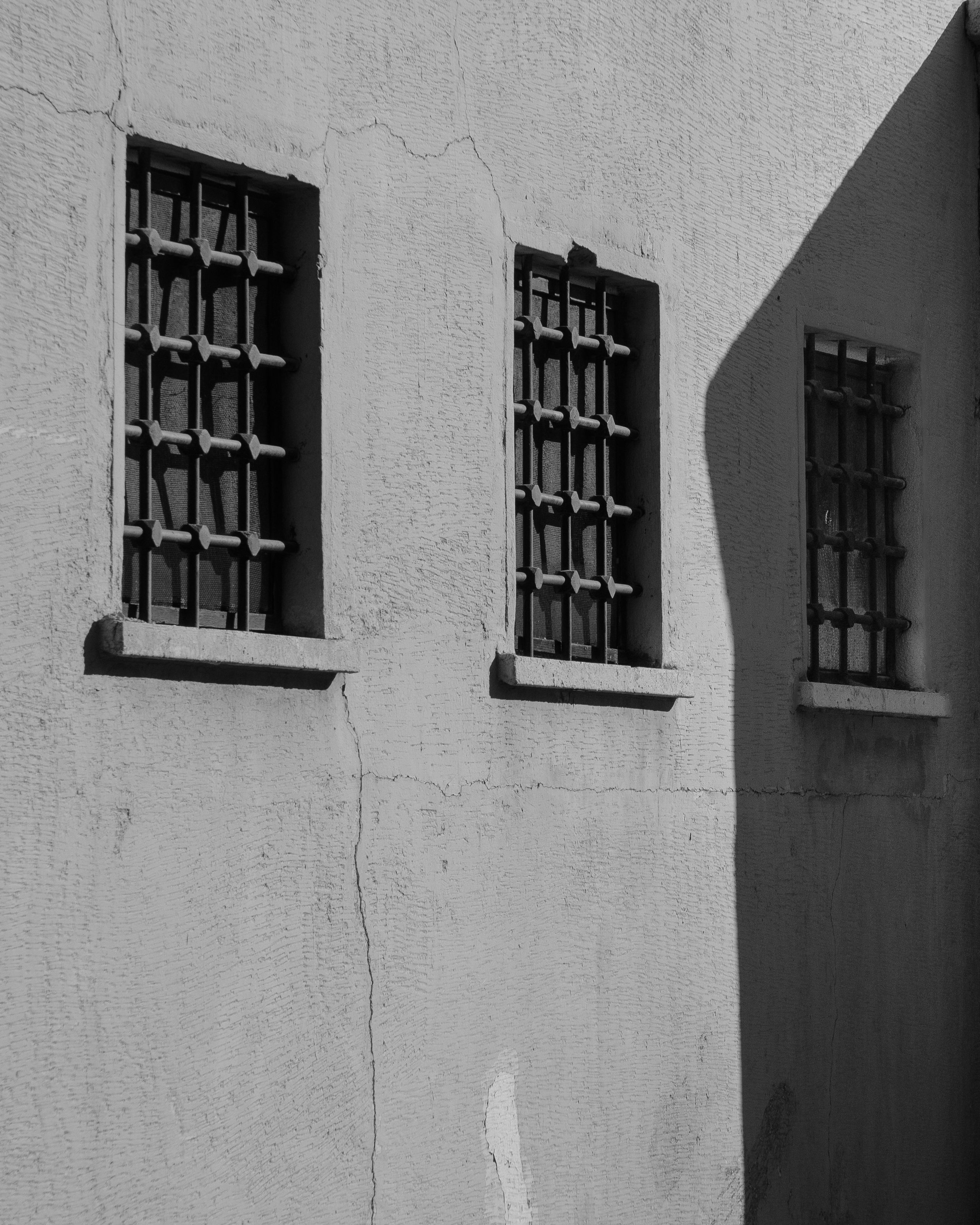 Monochrome Image of Prison Windows on Concrete Wall · Free Stock Photo