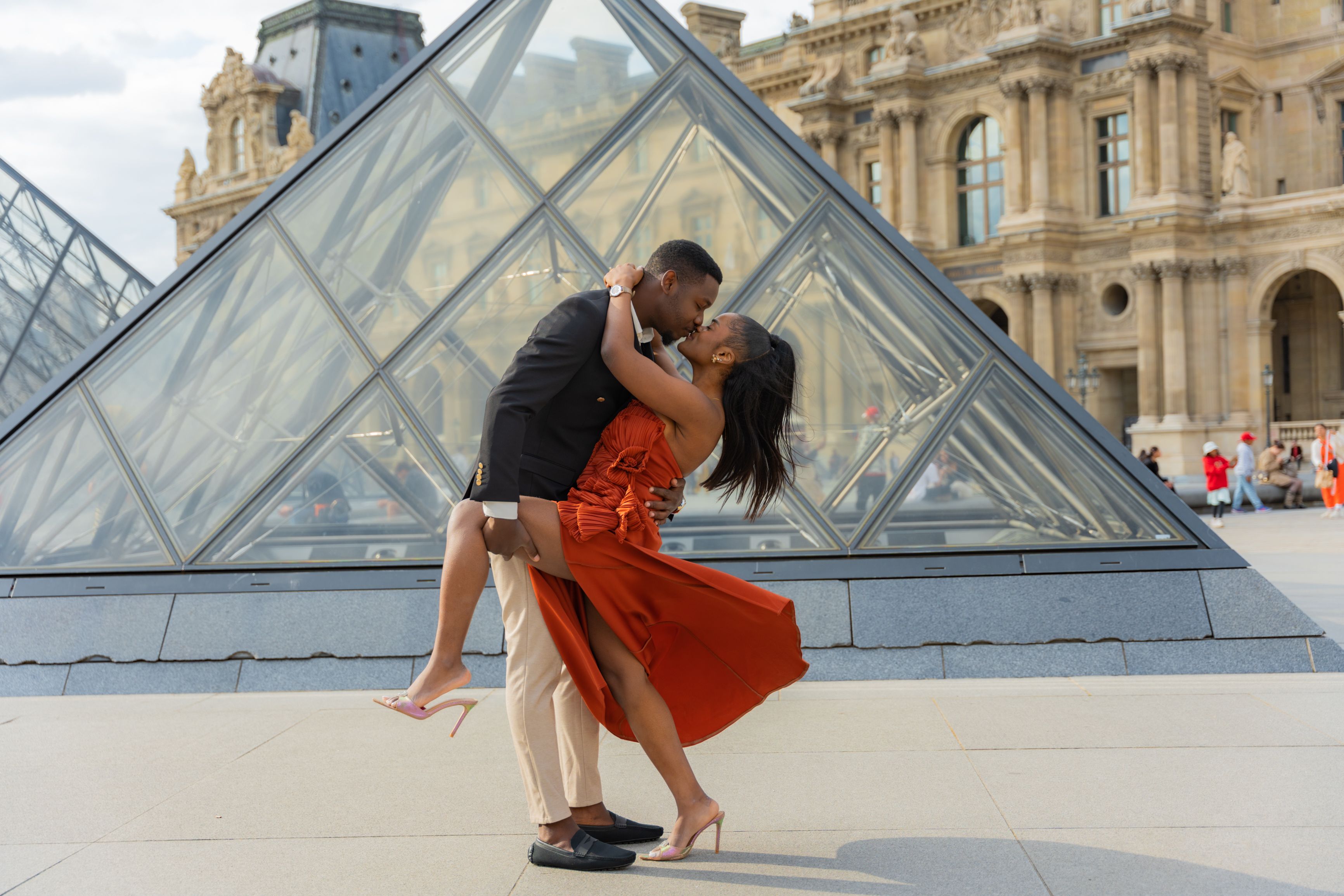 Romantic Couple Embracing at the Louvre Pyramid · Free Stock Photo