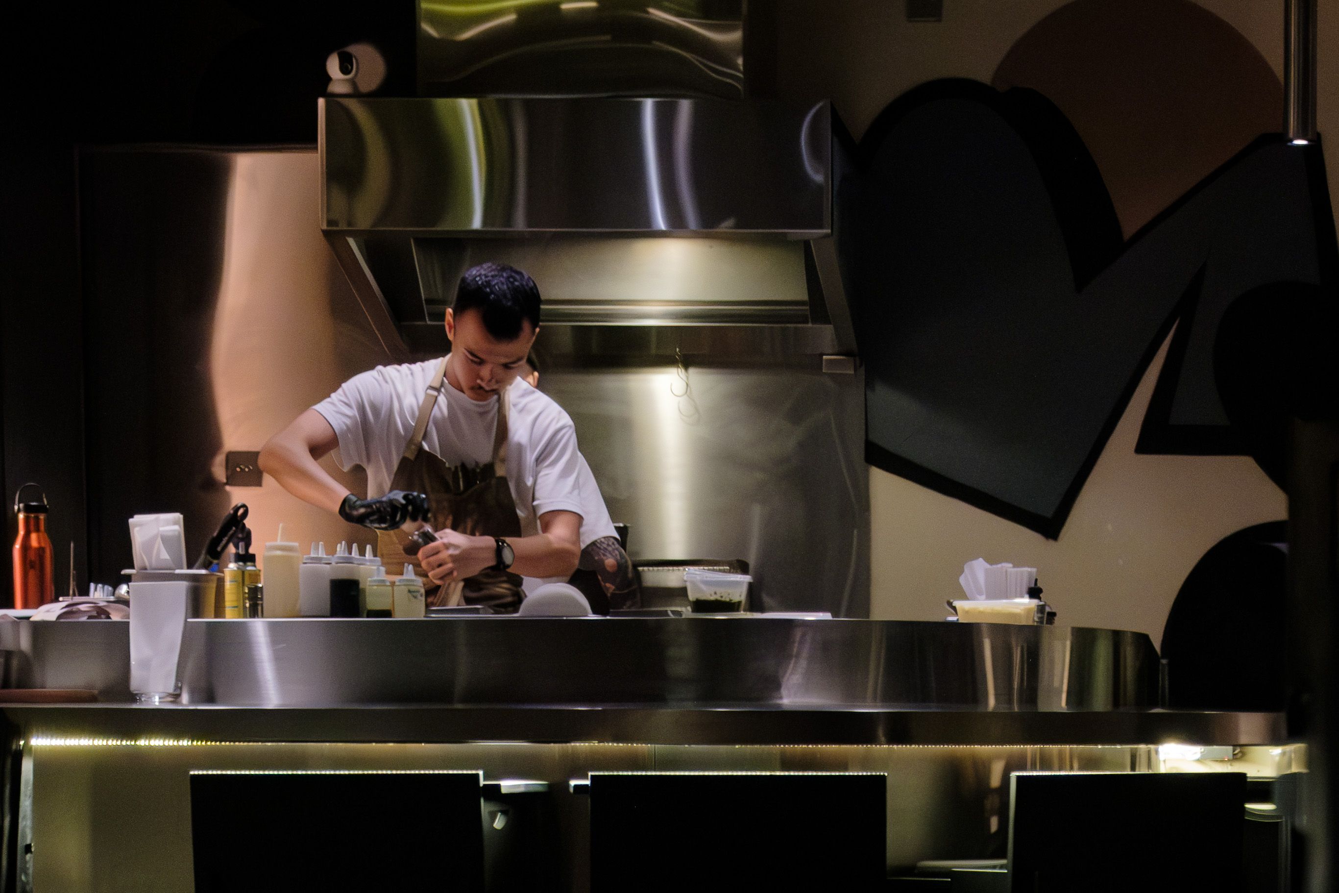 Professional Chef Preparing Gourmet Dish in Kitchen · Free Stock Photo
