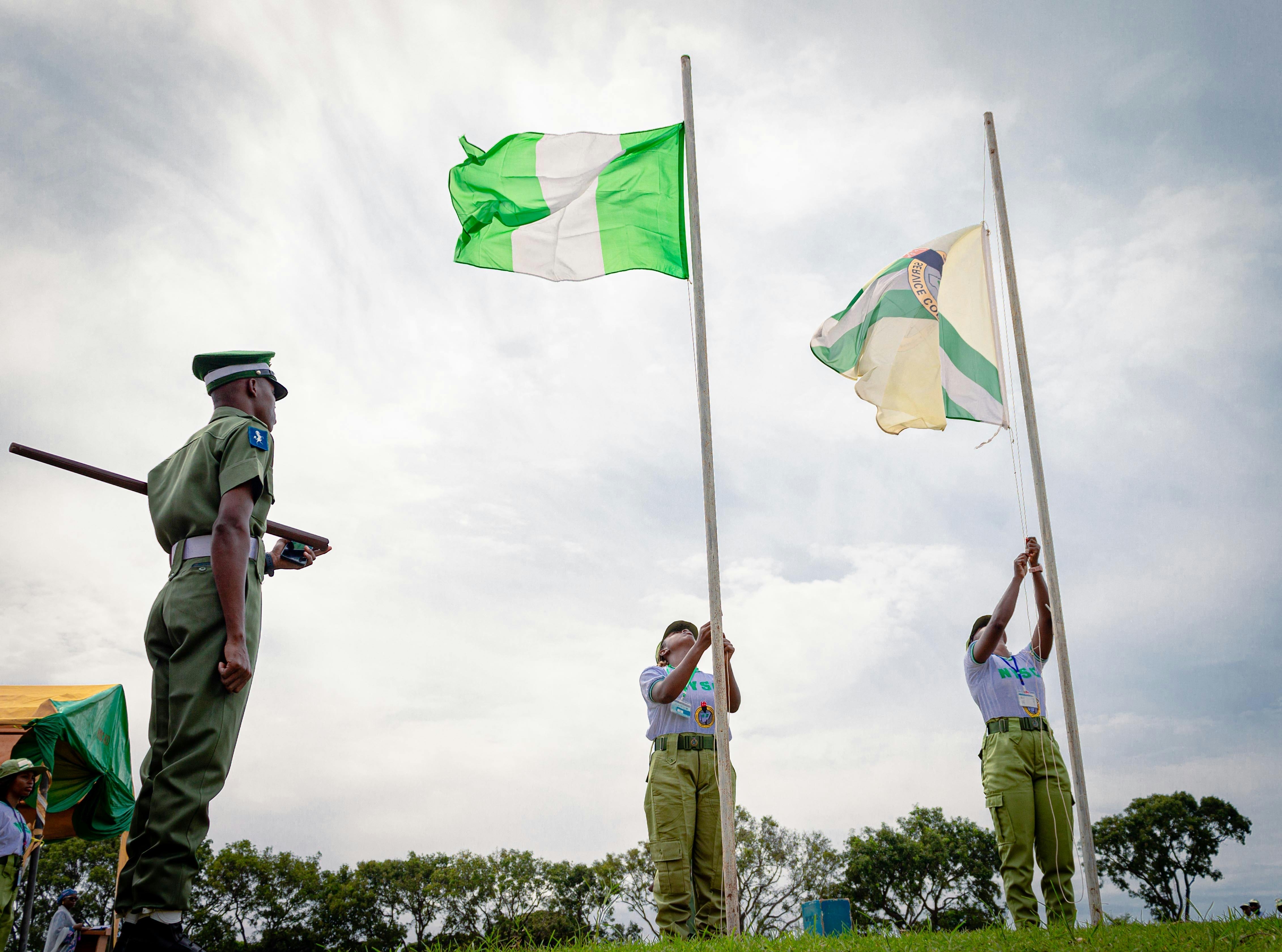 Nigerian Youths Raising Flags at Kaduna Ceremony · Free Stock Photo