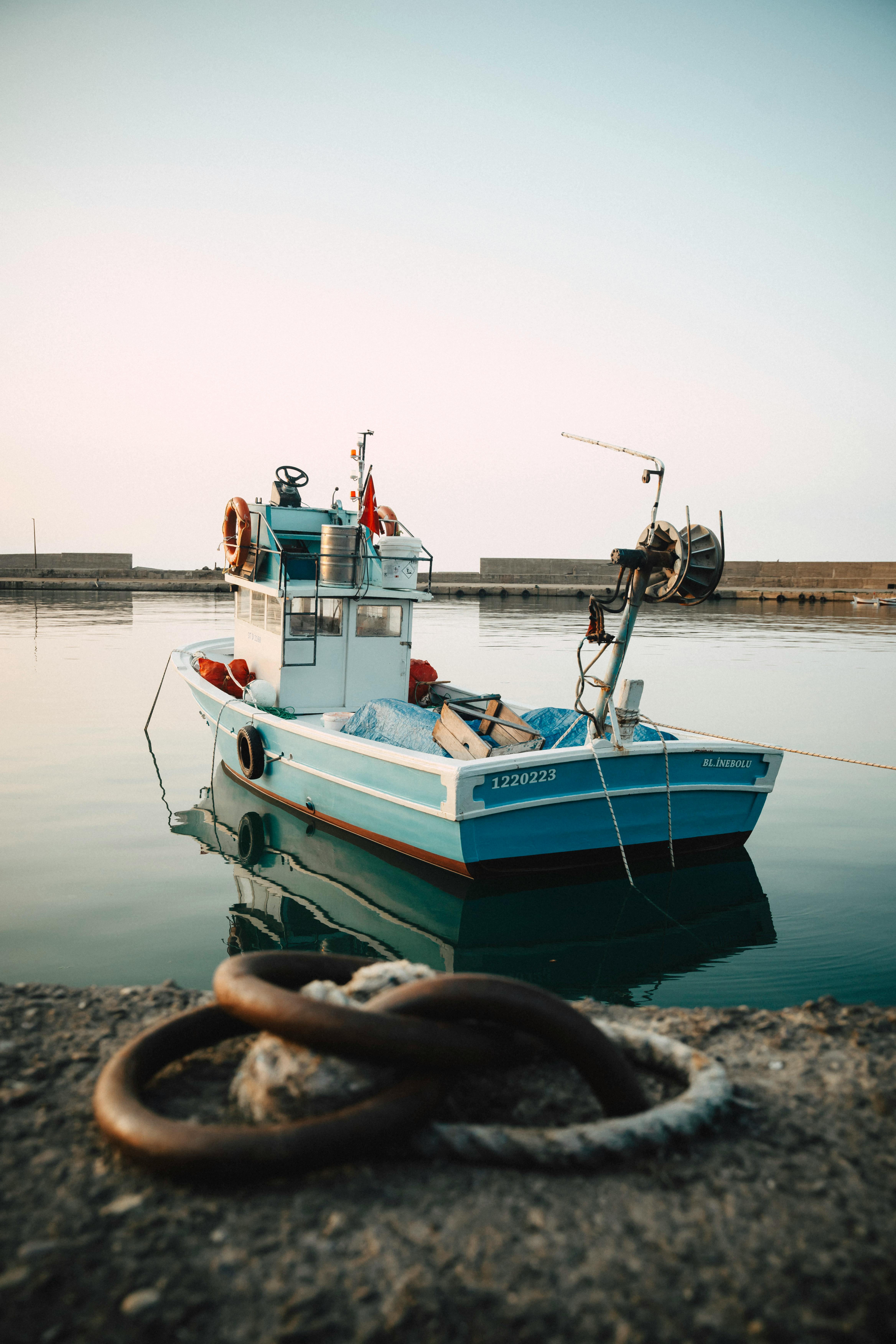 Fishing Boat Moored at Calm Harbor at Sunset · Free Stock Photo