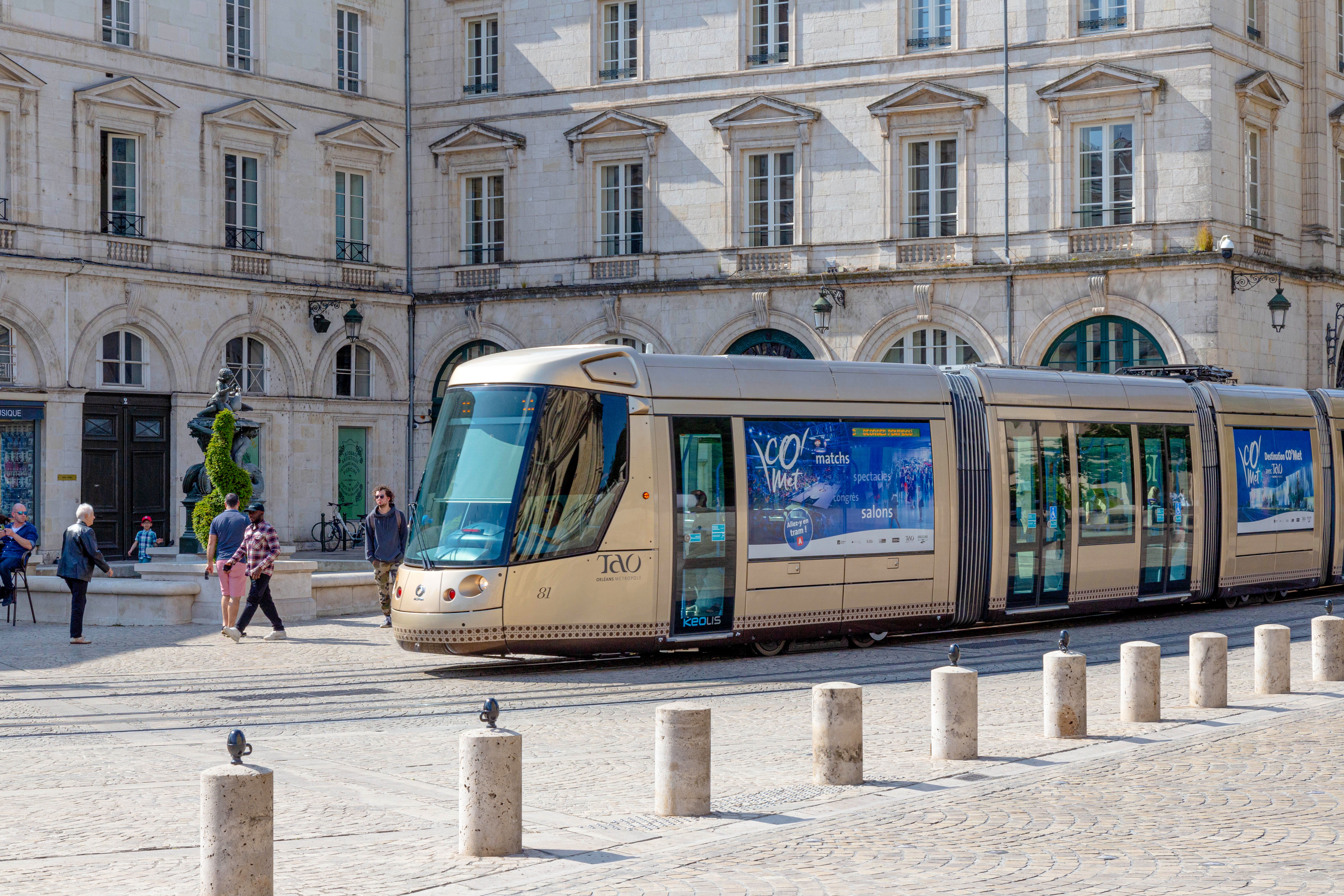 Modern Tram Passing Through Historic Orléans · Free Stock Photo