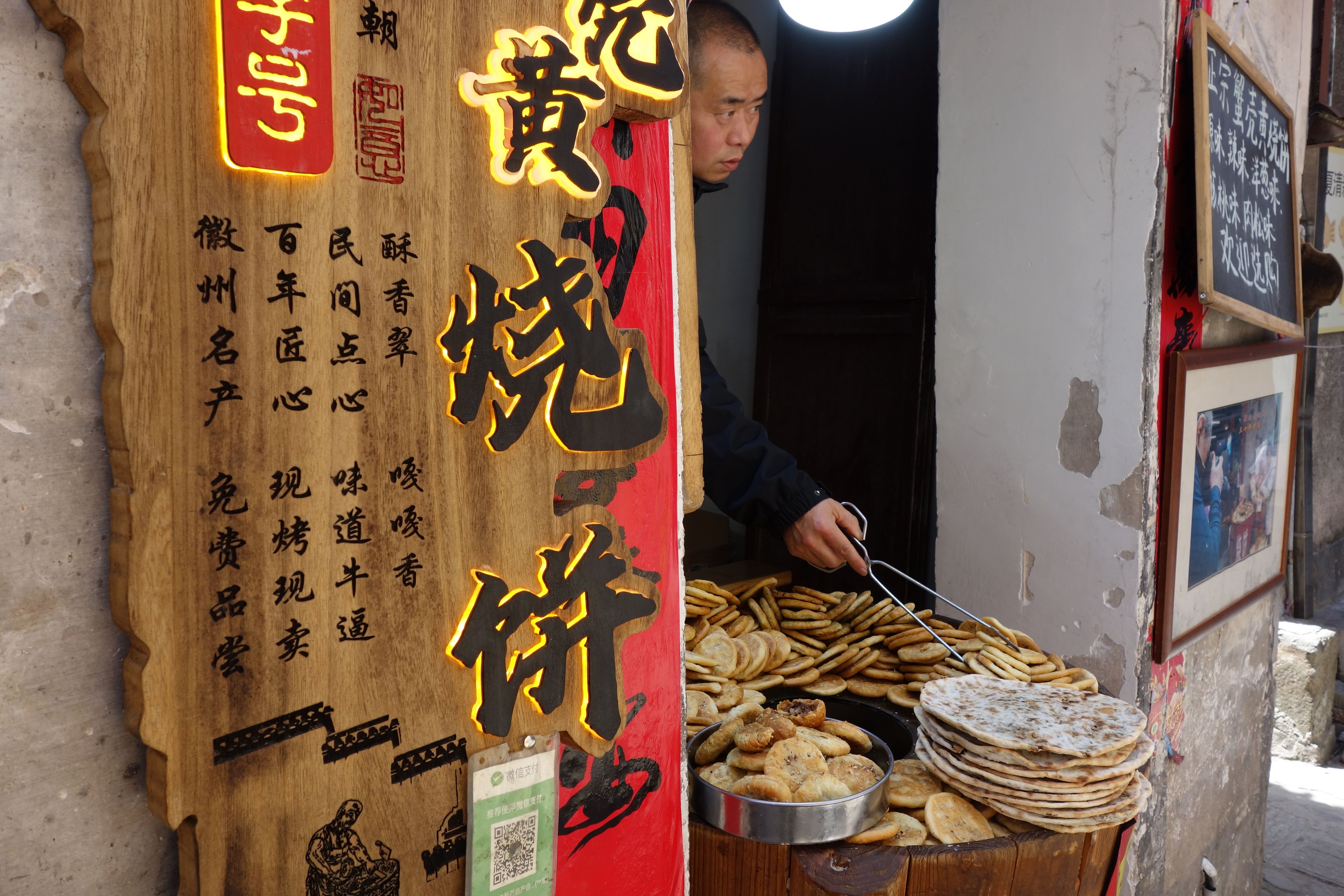 Street Vendor Selling Traditional Chinese Pastries · Free Stock Photo