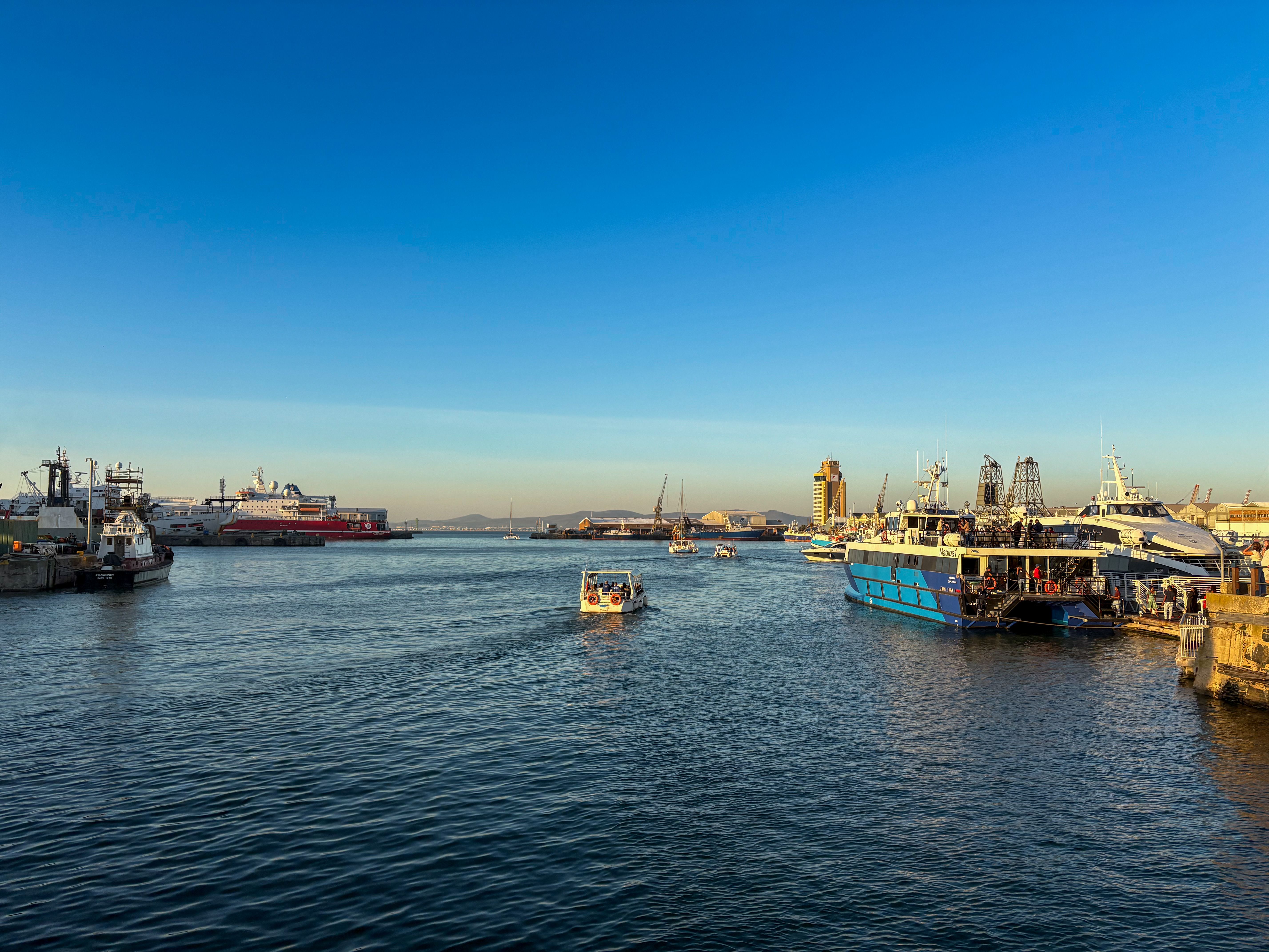 Vibrant Harbor Scene with Boats and Blue Skies · Free Stock Photo