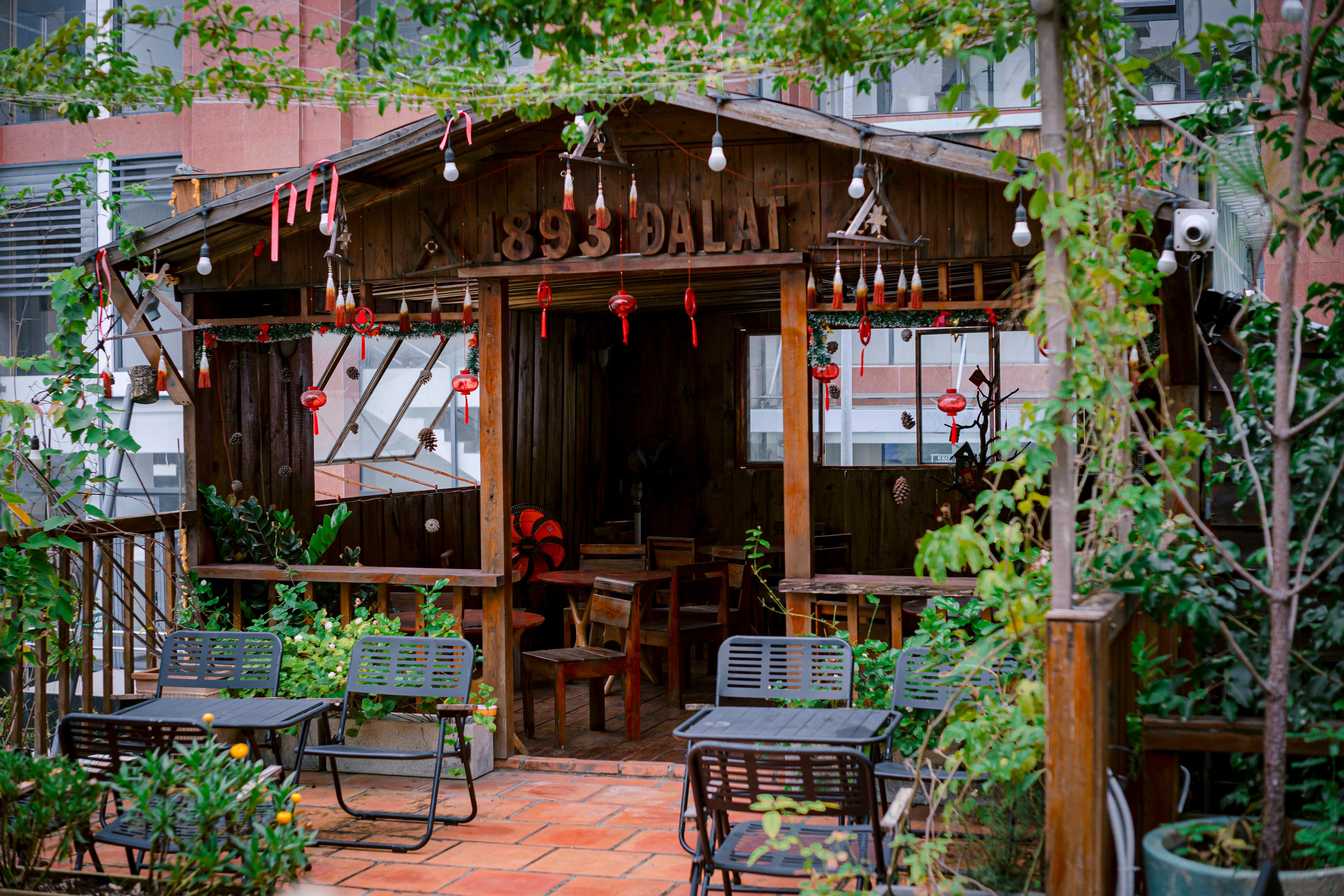 Charming Wooden Cafe Terrace with Lanterns · Free Stock Photo
