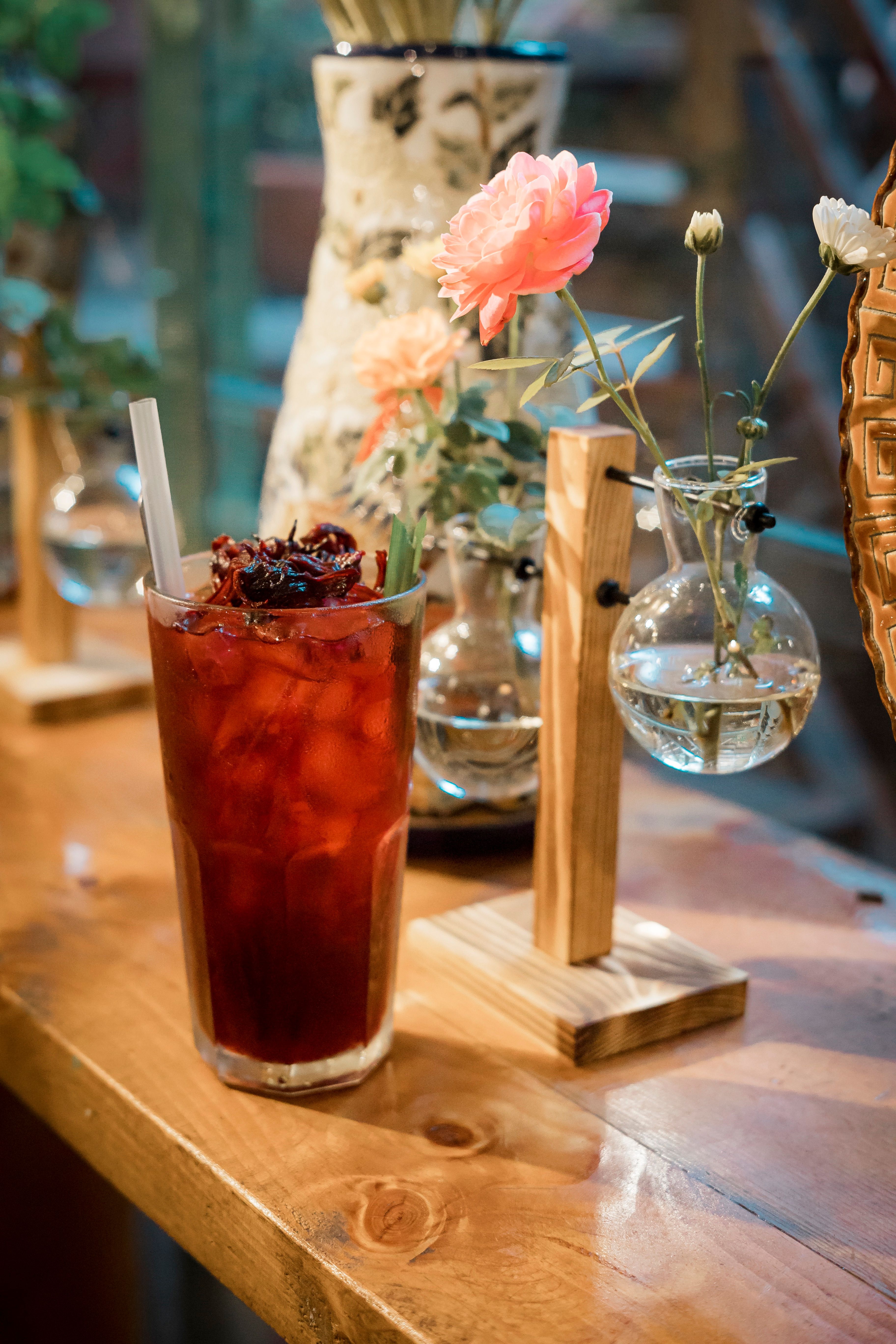 Refreshing Hibiscus Iced Tea with Vase Flower Decor · Free Stock Photo
