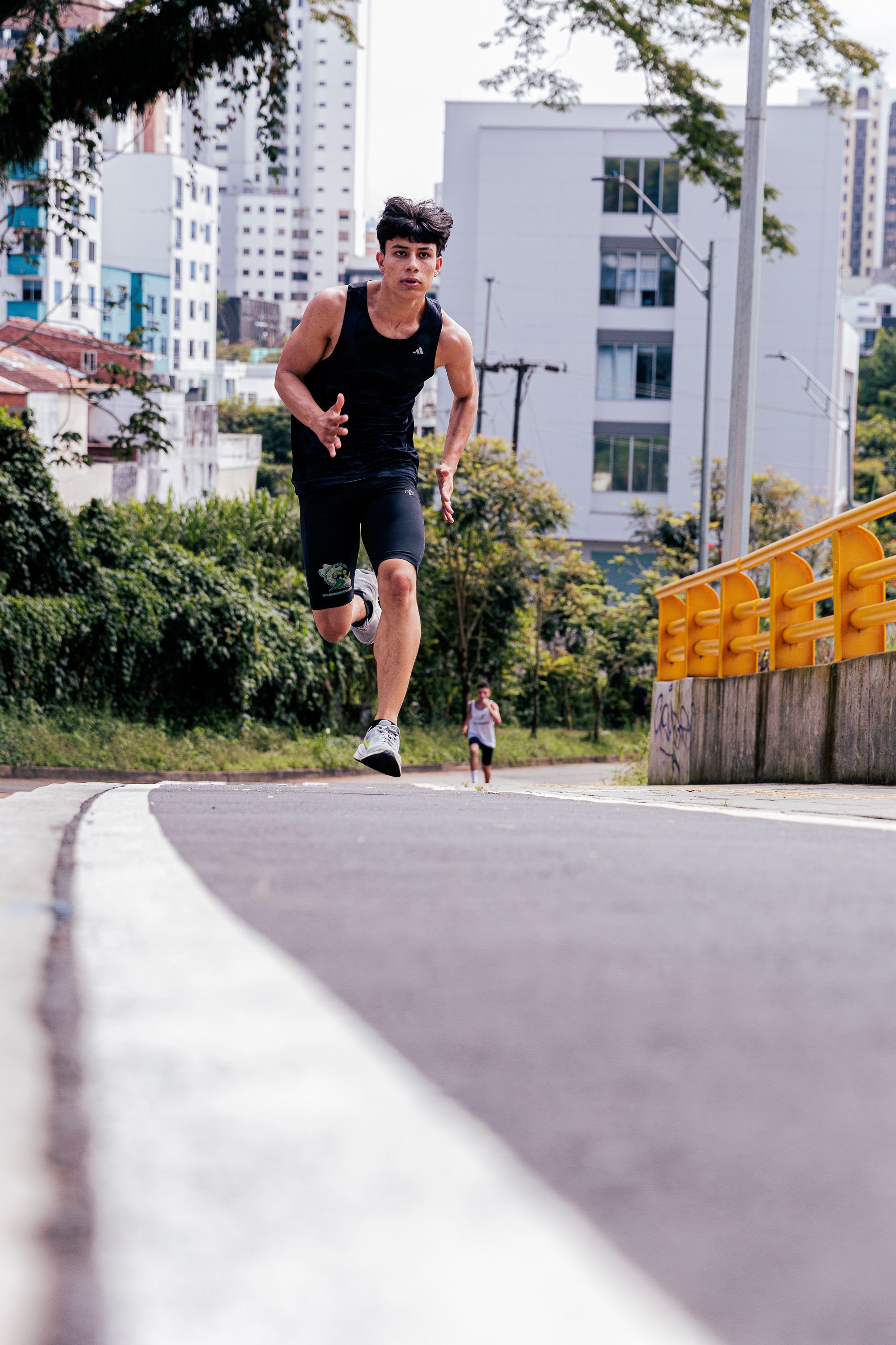 Man Running on Urban Path with Vibrant Building Backdrop · Free Stock Photo