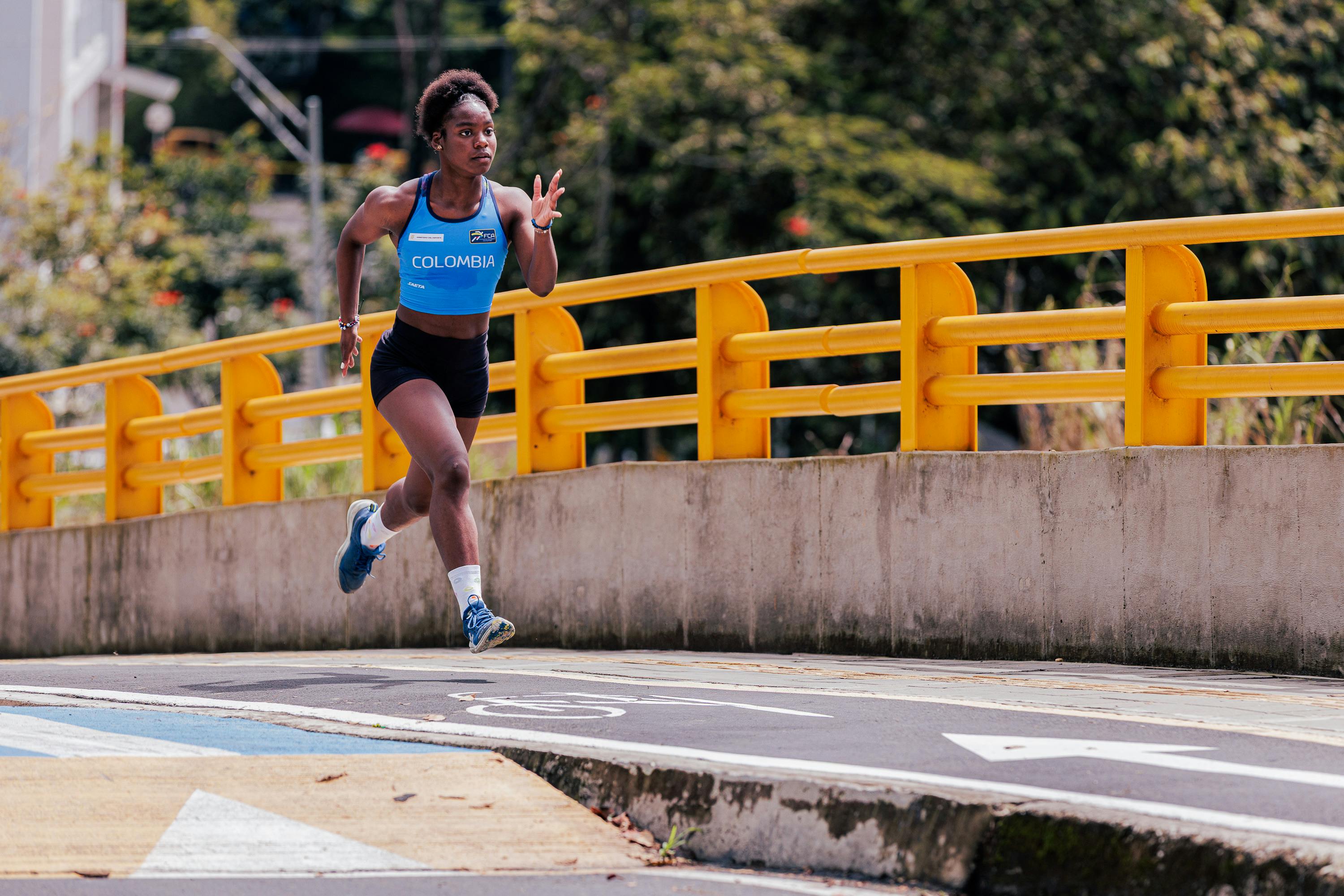 Female Runner on a Vibrant City Roadway · Free Stock Photo
