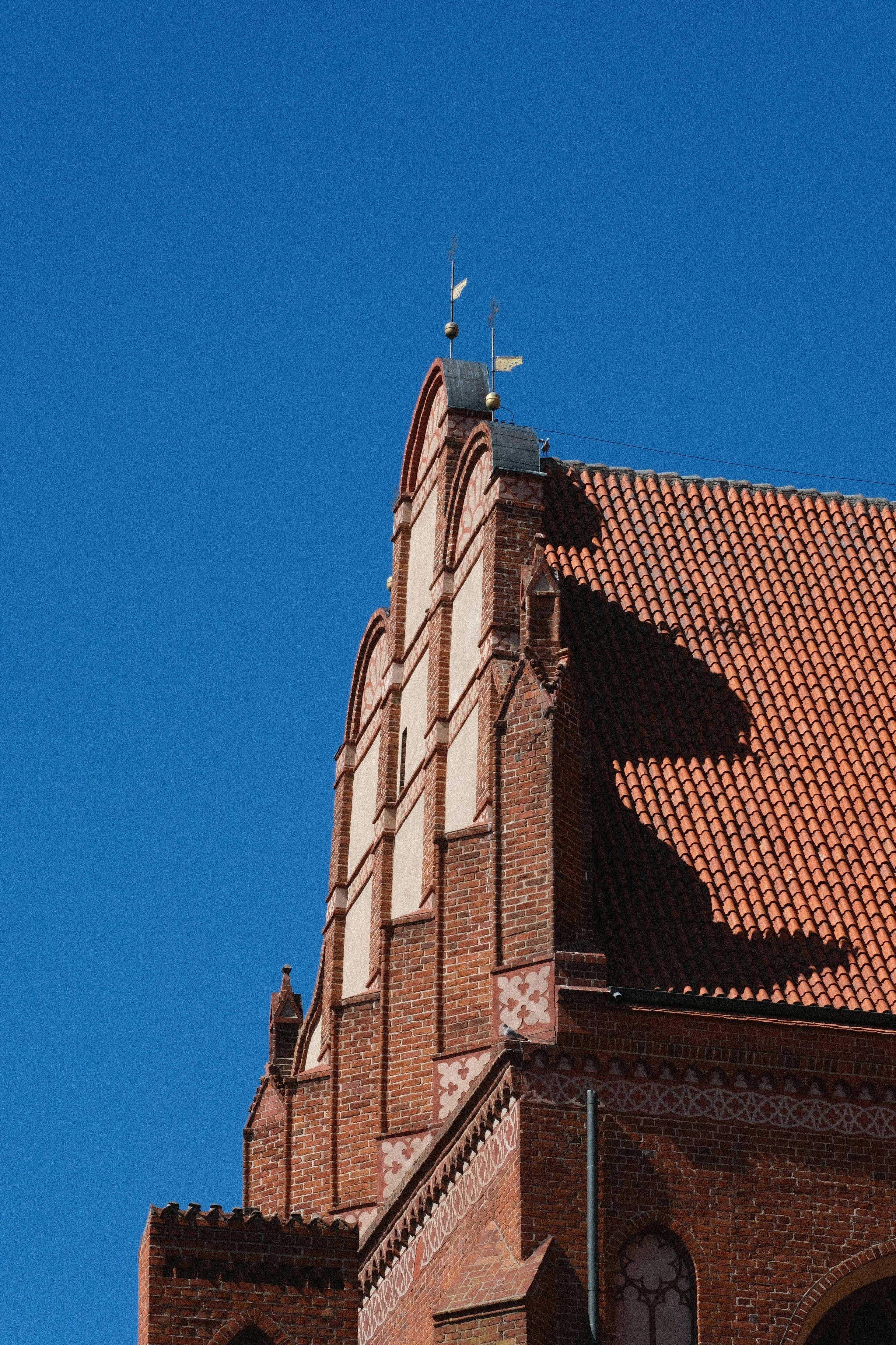 Gothic Brick Architecture Against Clear Sky · Free Stock Photo