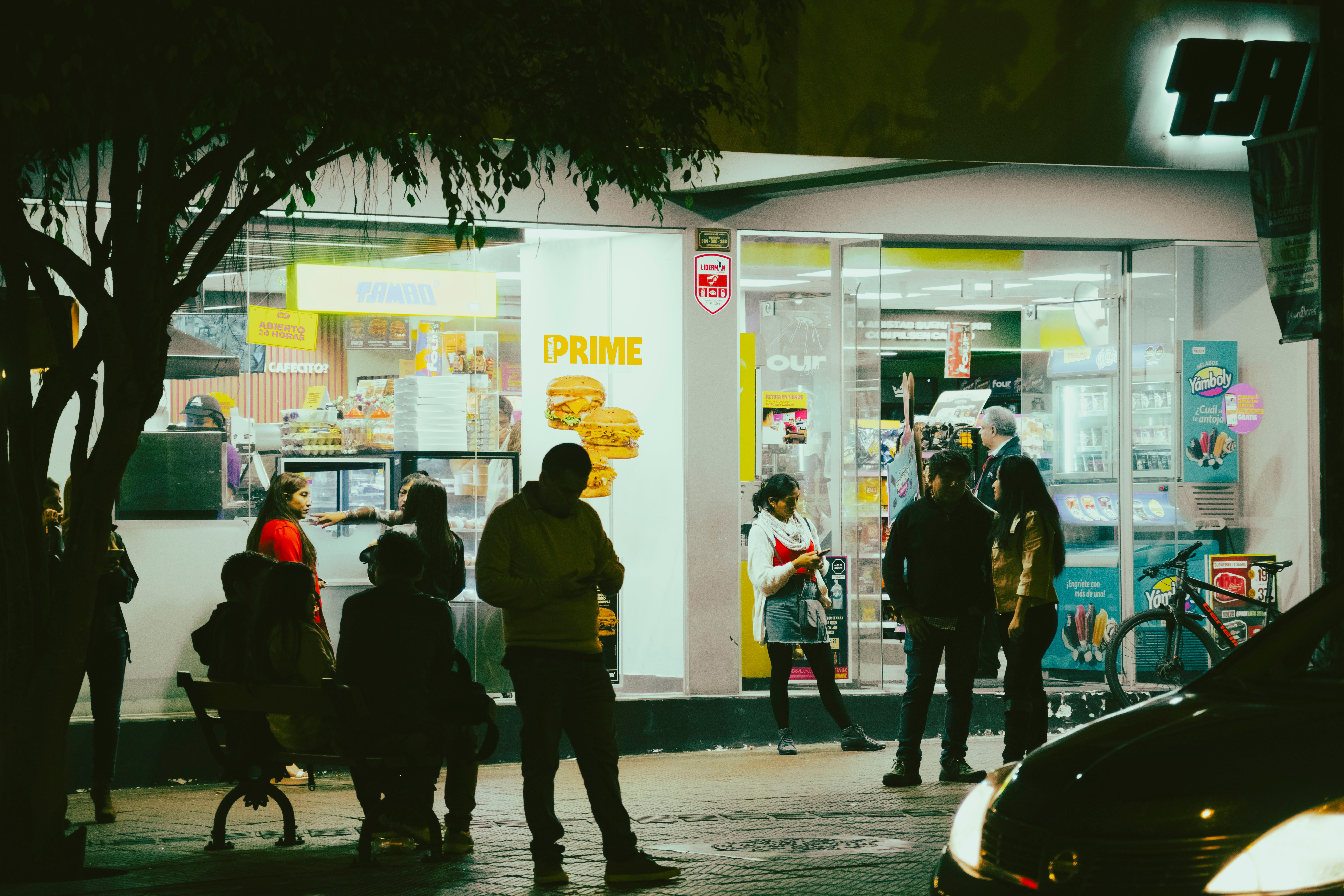 Nighttime Convenience Store Gathering · Free Stock Photo