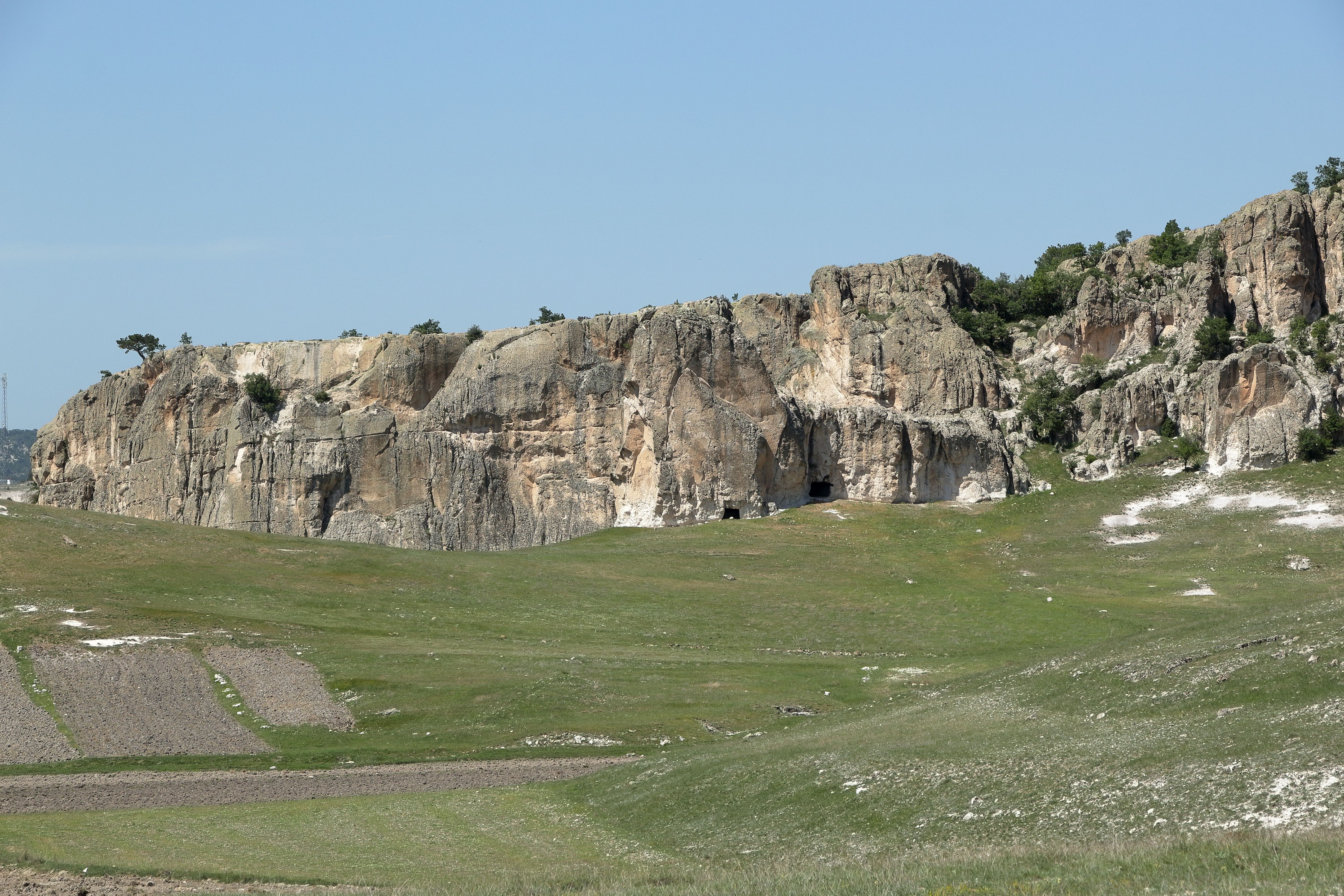 Scenic Rocky Cliff Landscape in Open Grasslands · Free Stock Photo