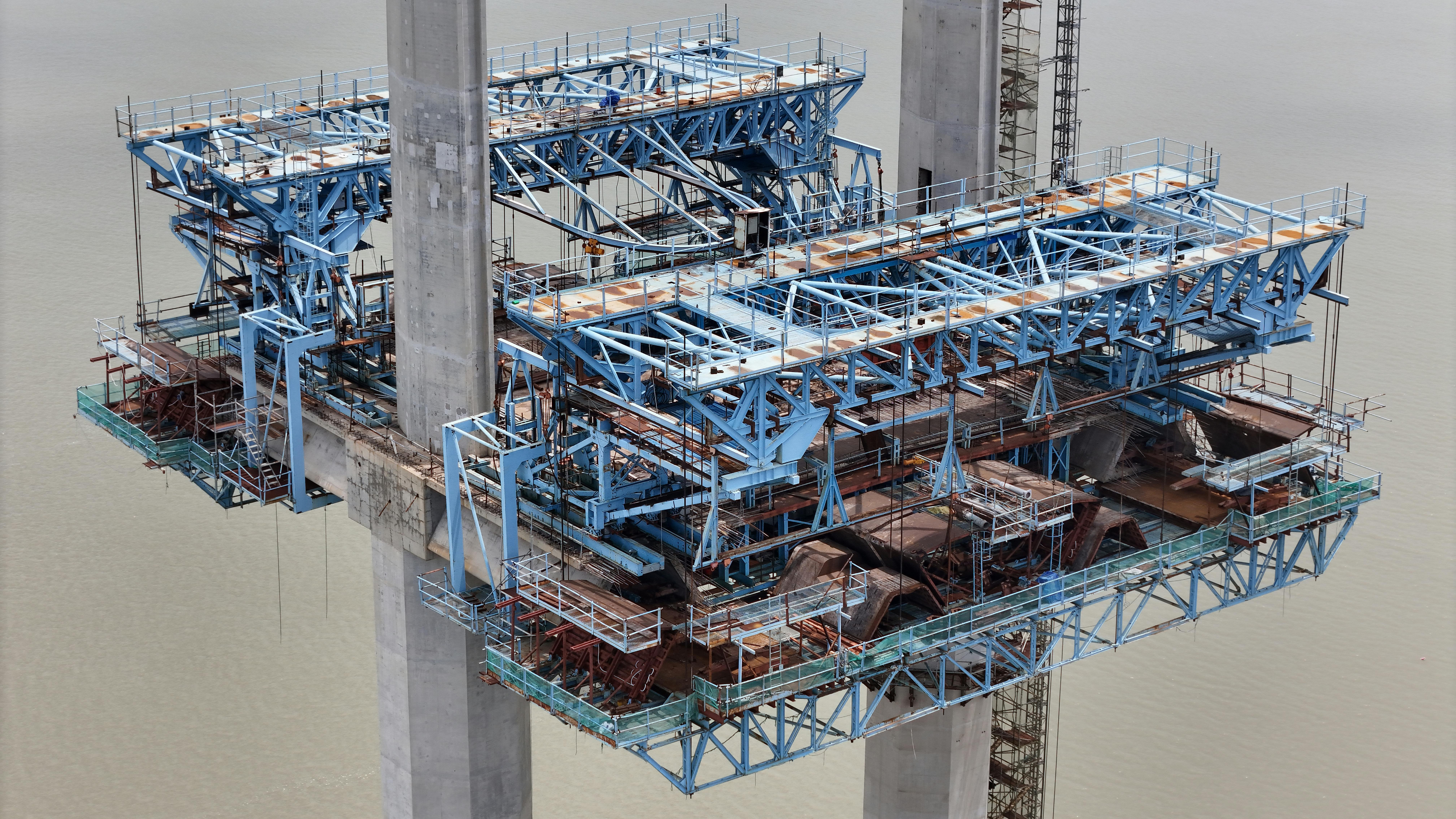 Industrial Bridge Construction in Progress Above Water · Free Stock Photo