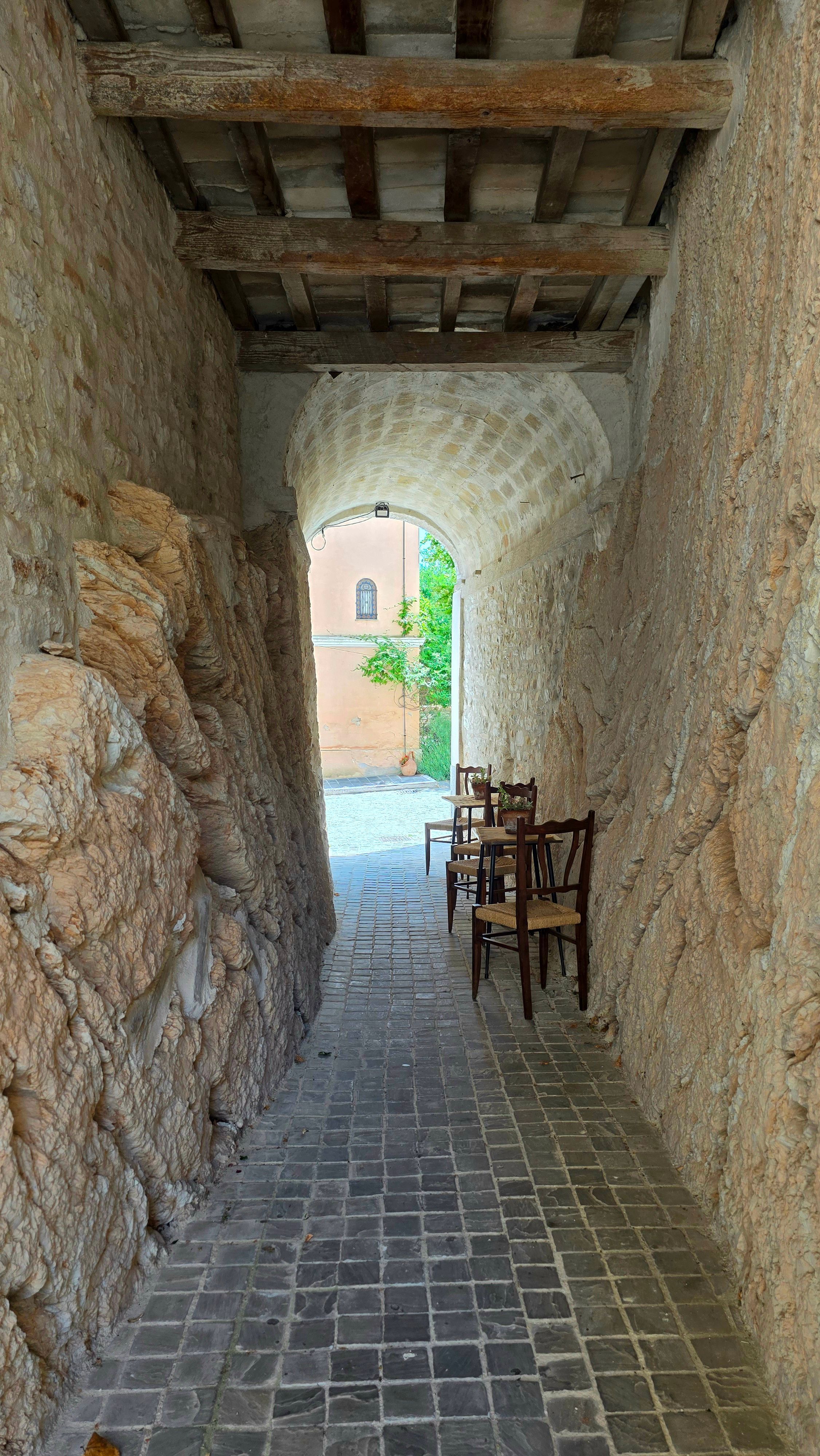 Rustic Stone Corridor with Wooden Chairs · Free Stock Photo