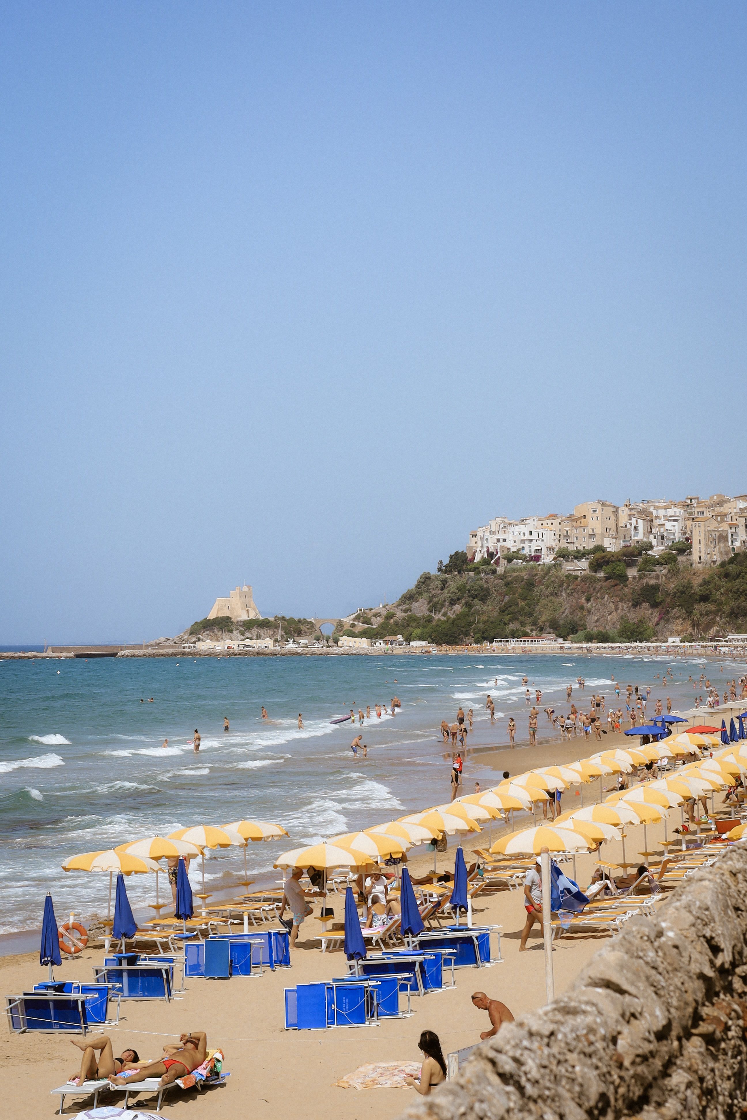 Sunny Mediterranean Beach with Umbrellas and Cliffside Homes · Free ...