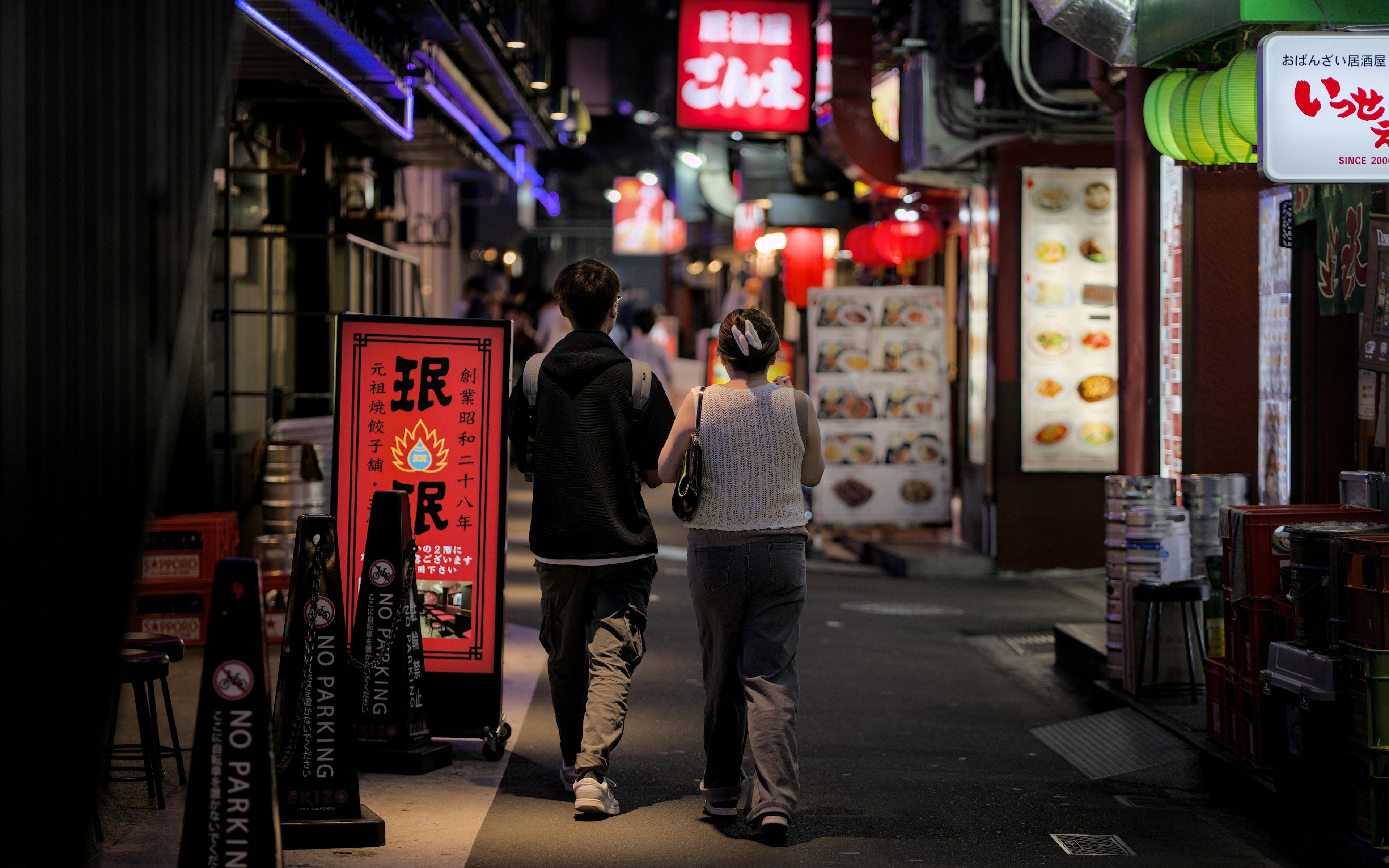Couple Walking in Kobe's Vibrant Nightlife Scene · Free Stock Photo