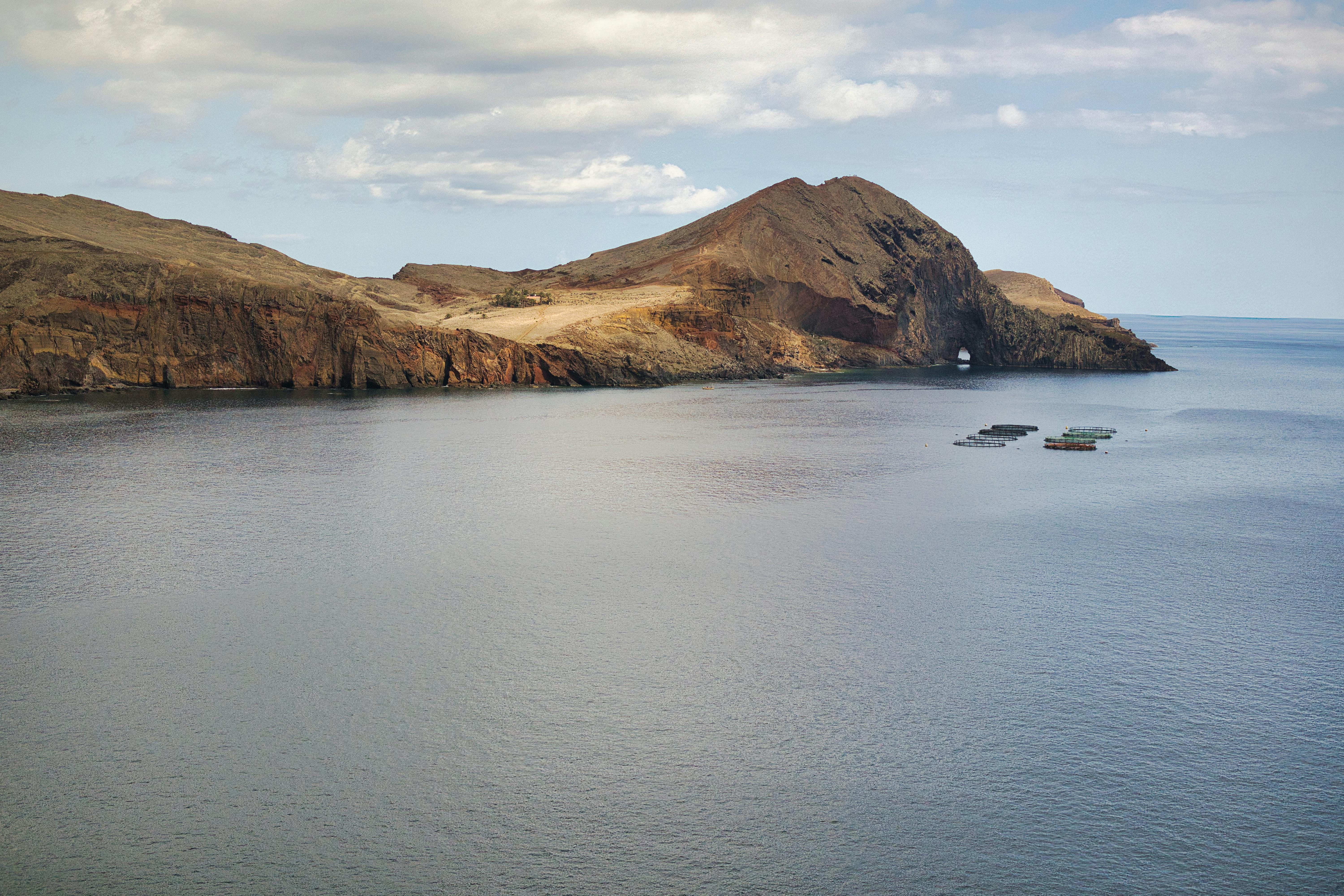 Dramatic Coastal Cliff with Calm Ocean View · Free Stock Photo