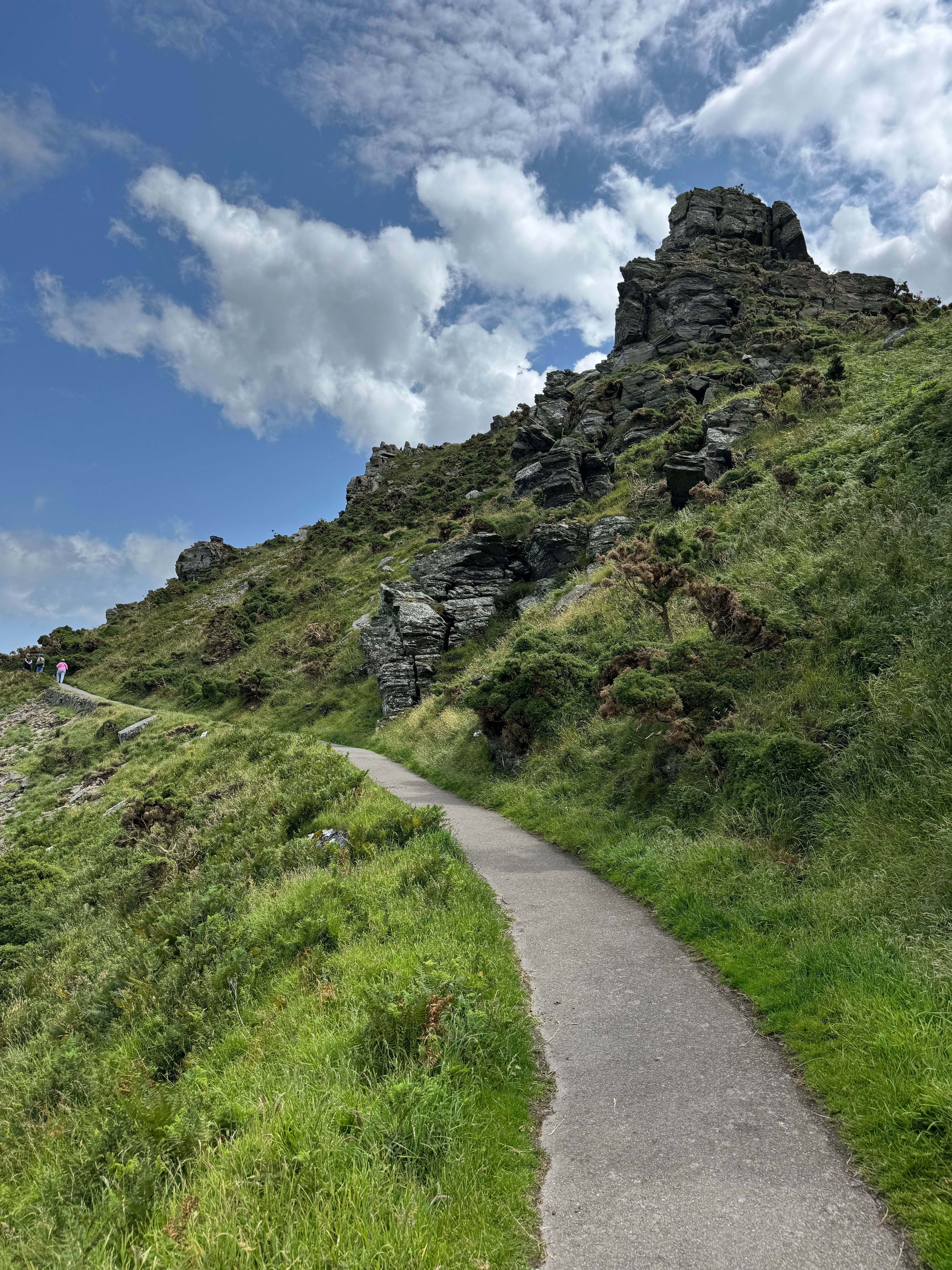 Scenic Rocky Cliff Pathway Under Blue Sky · Free Stock Photo