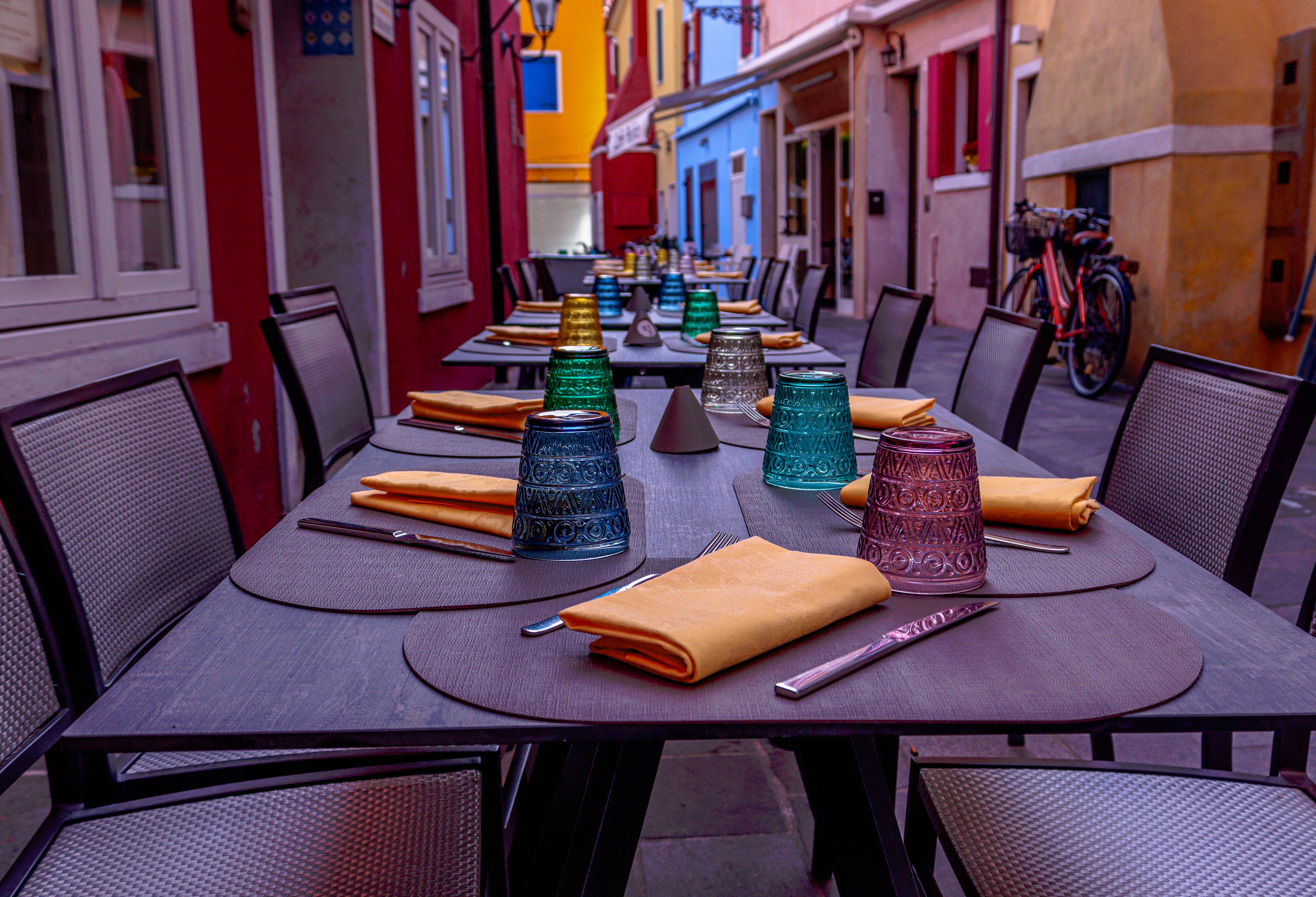 Vibrant Outdoor Dining in Colorful Alley · Free Stock Photo