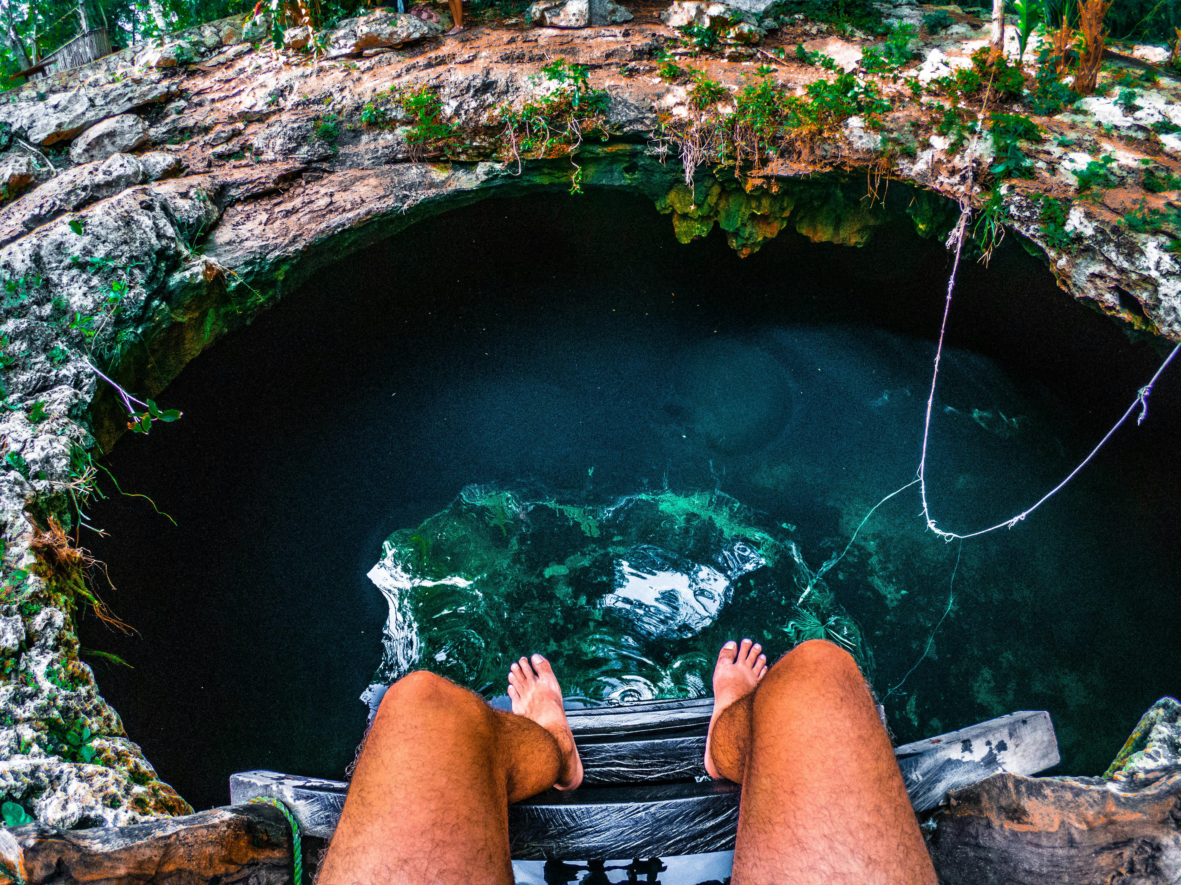 Person Sitting on a Ladder With View Of Underground Water · Free Stock ...
