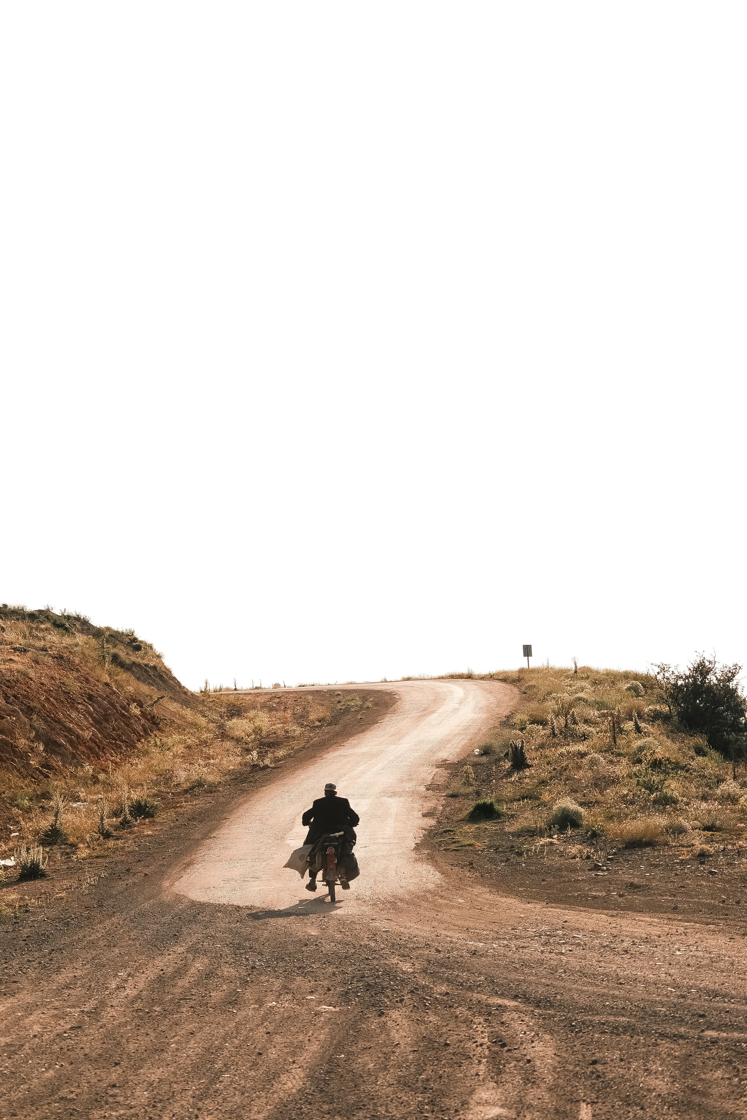 Lone Rider on a Remote Dirt Road · Free Stock Photo