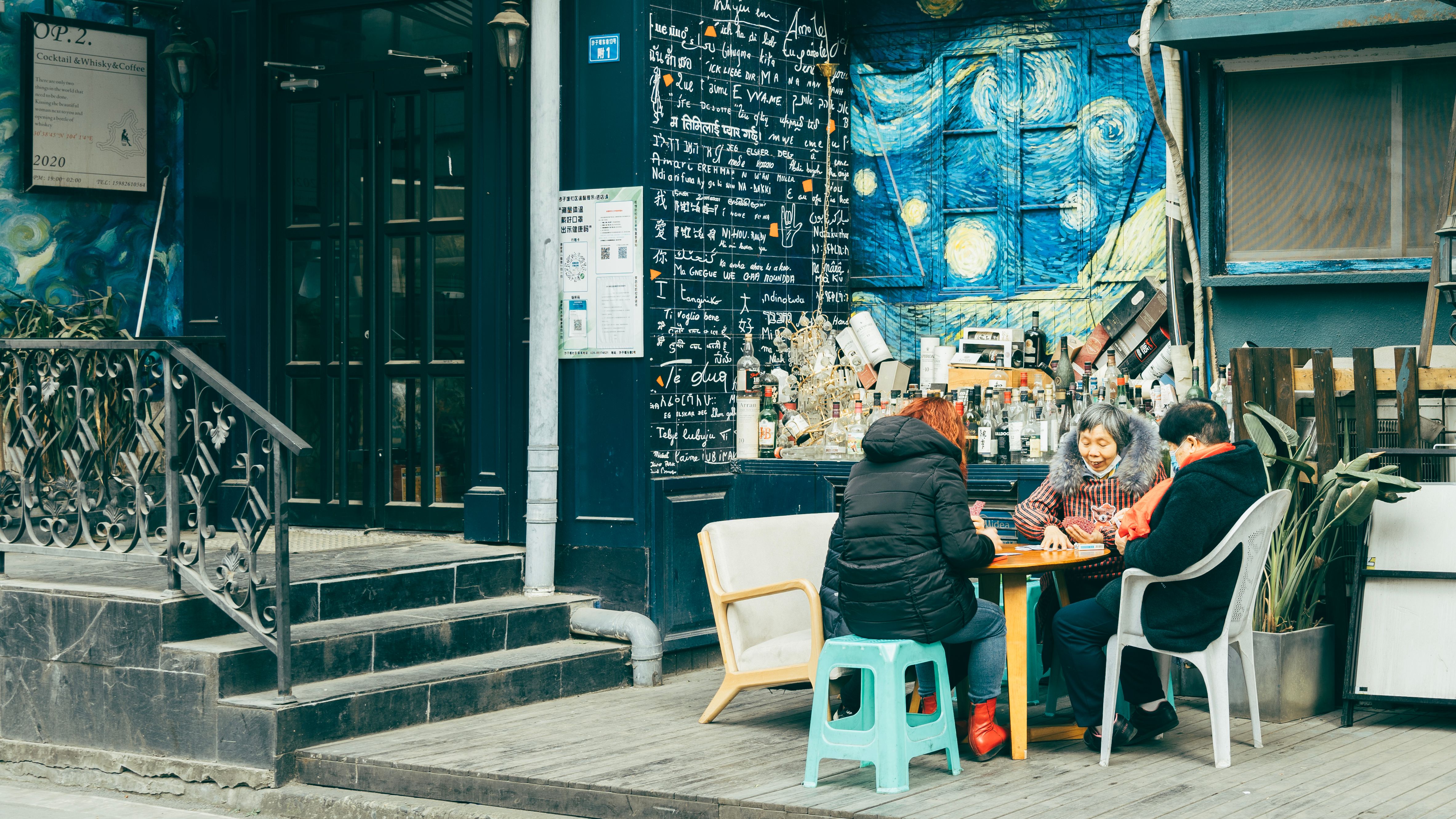 Cozy Outdoor Cafe with Starry Night Mural · Free Stock Photo