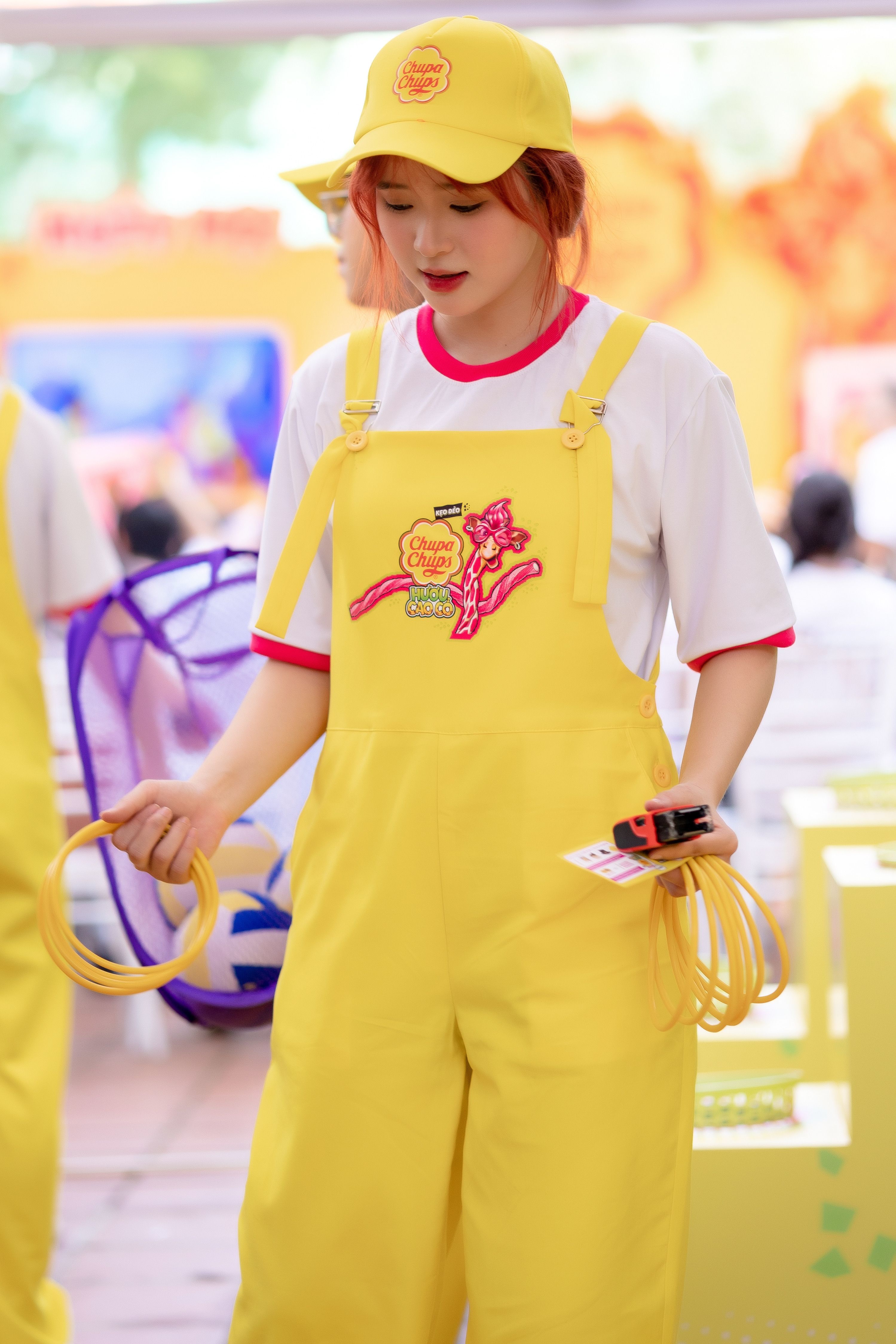 Young Woman in Vibrant Yellow Attire at Event · Free Stock Photo
