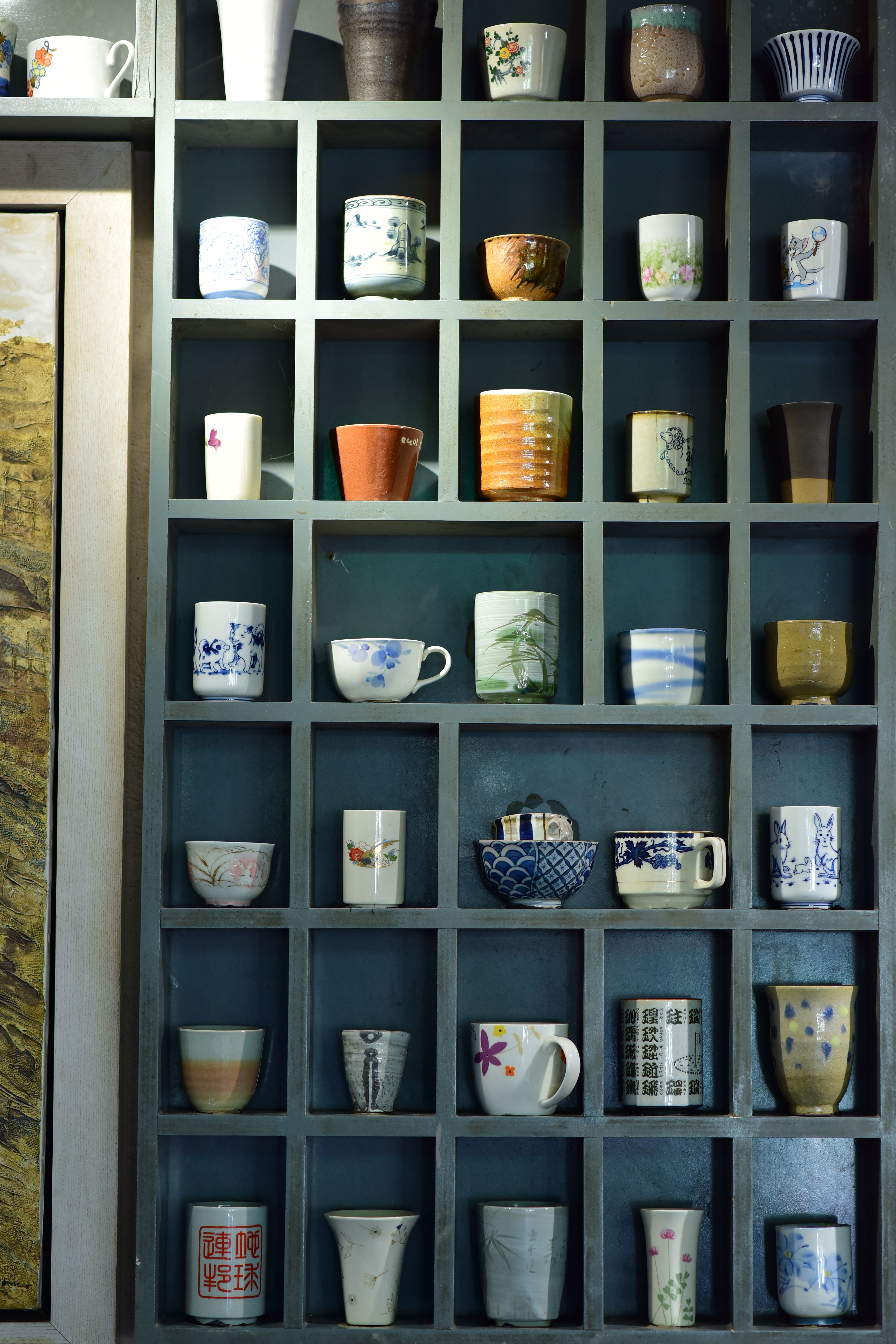 Collection of Decorative Ceramics on Display Shelf · Free Stock Photo