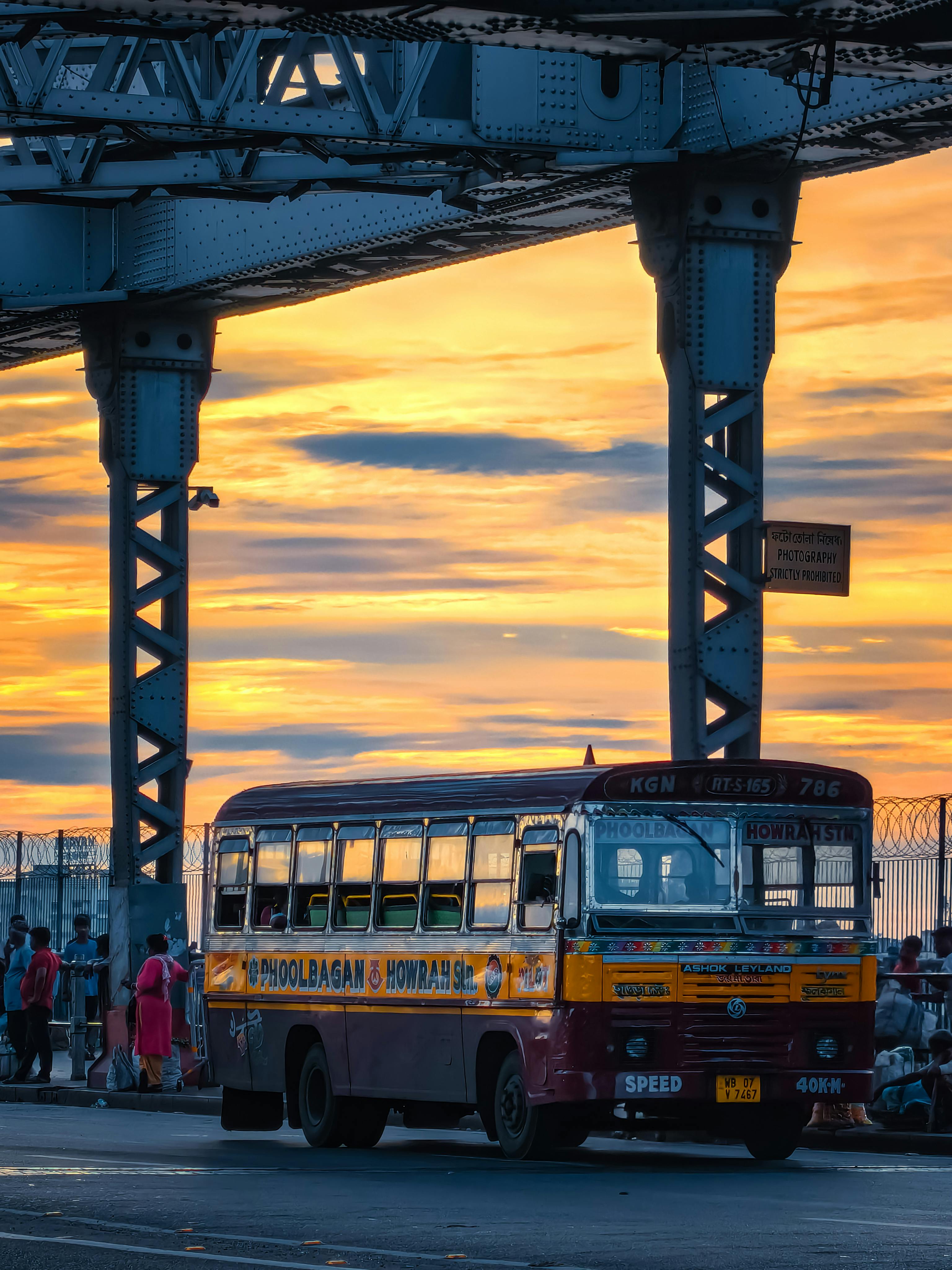 Iconic Yellow Bus at Howrah Bridge Sunset · Free Stock Photo