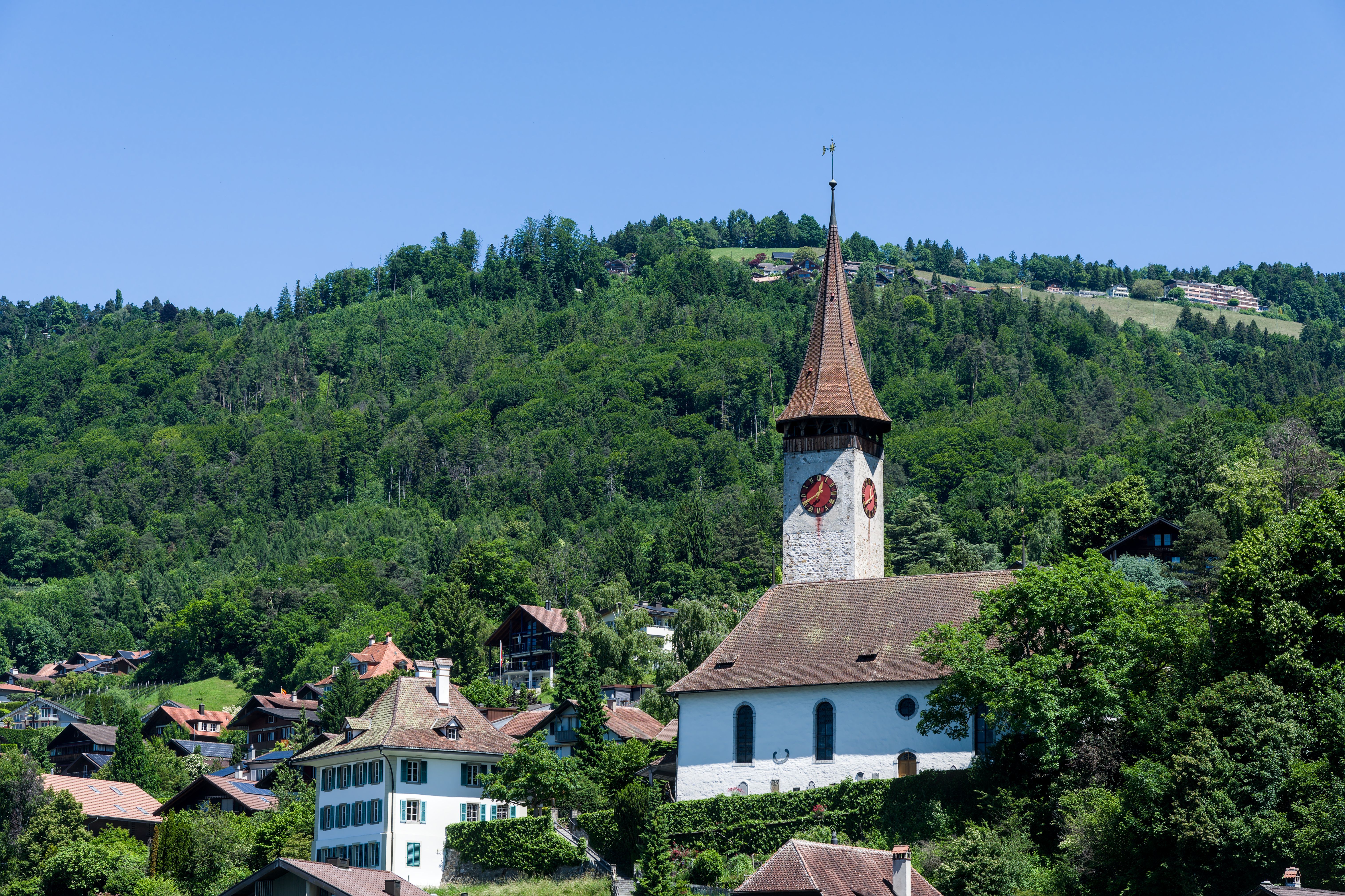 Historic Swiss Church with Lush Green Hillside · Free Stock Photo