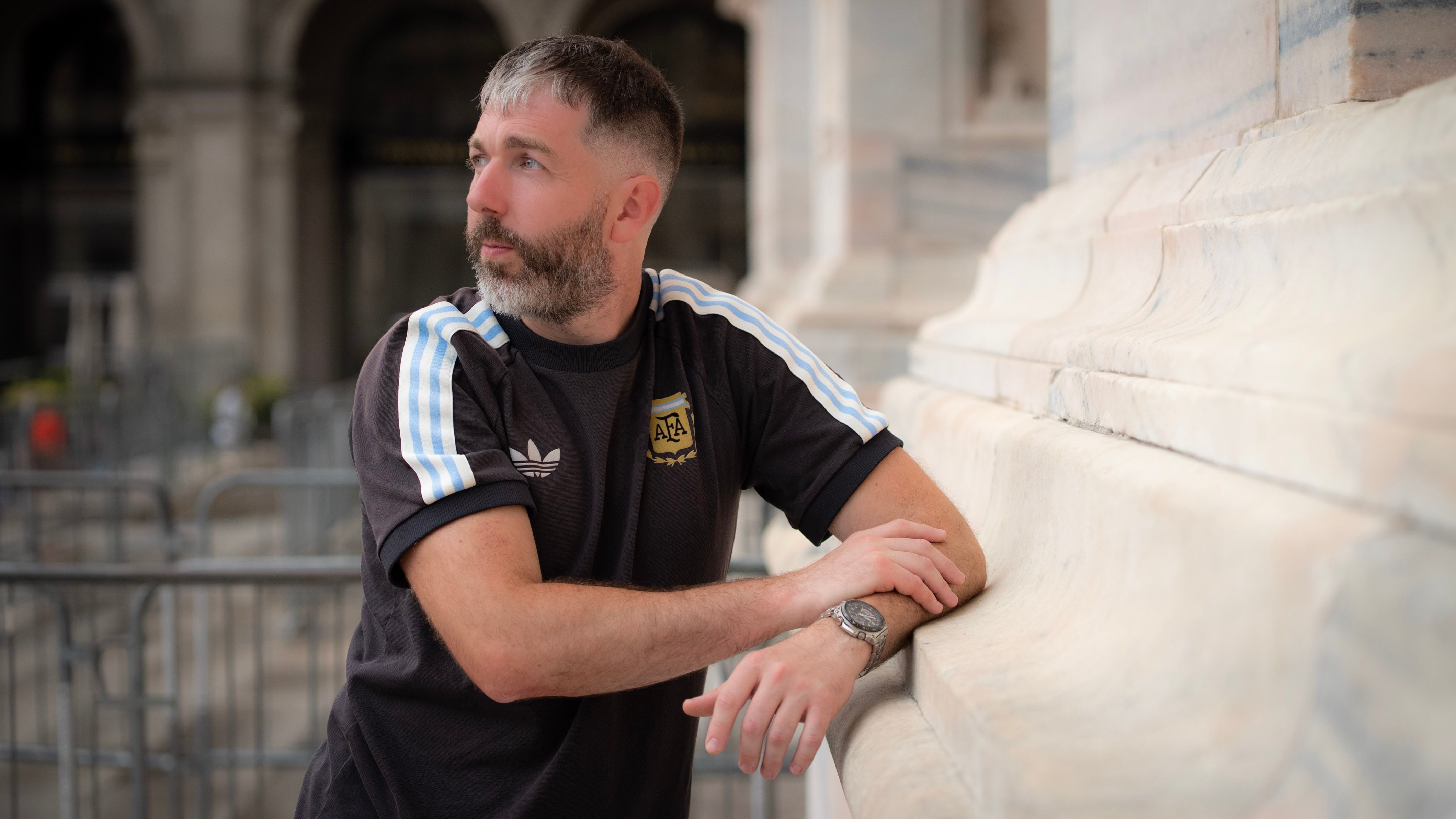 Stylish Man Leaning Against Marble in Milan · Free Stock Photo