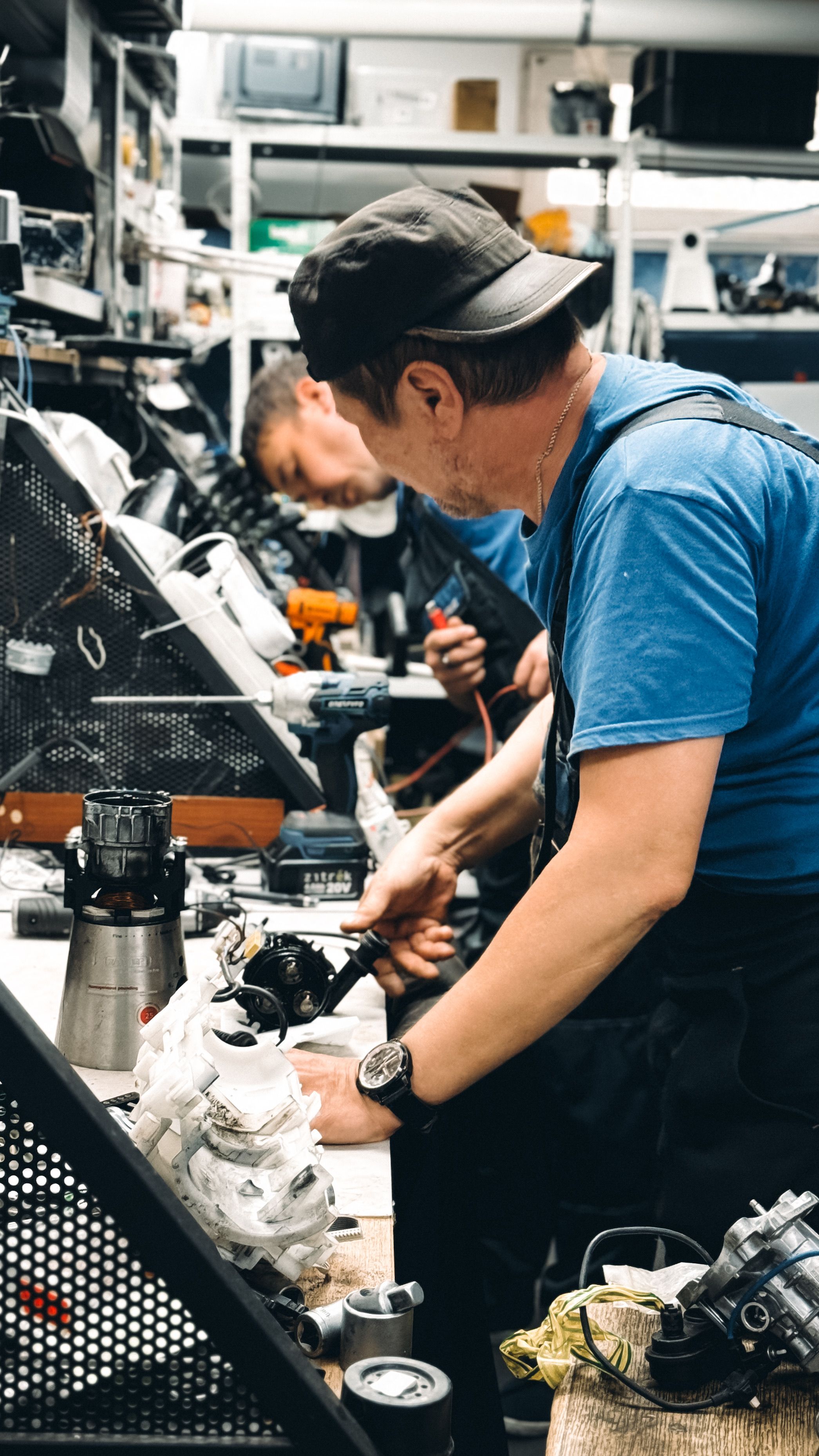 Industrial Workers Repairing Machinery in Workshop · Free Stock Photo