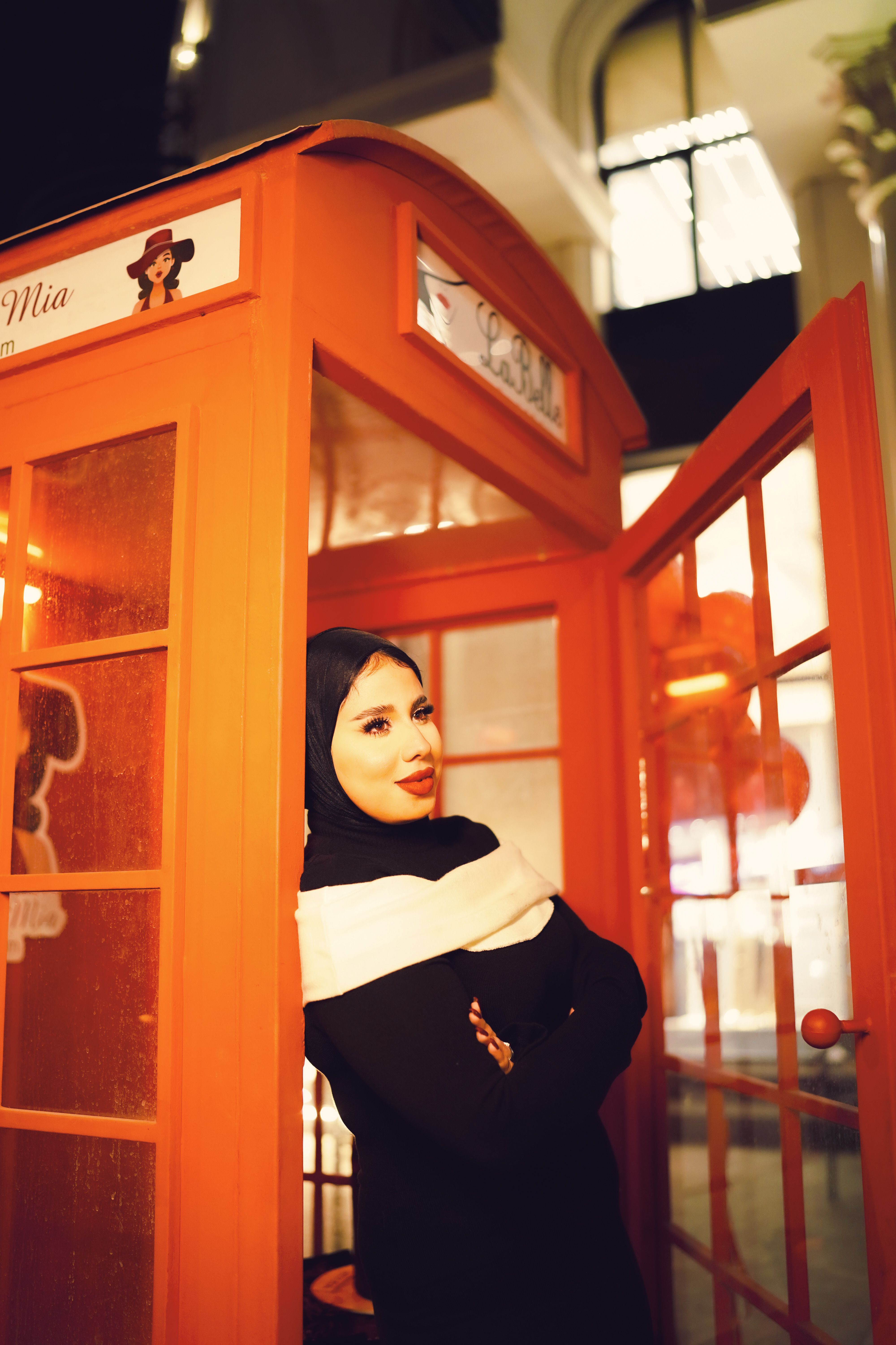 Stylish Woman by Vintage Red Phone Booth at Night · Free Stock Photo