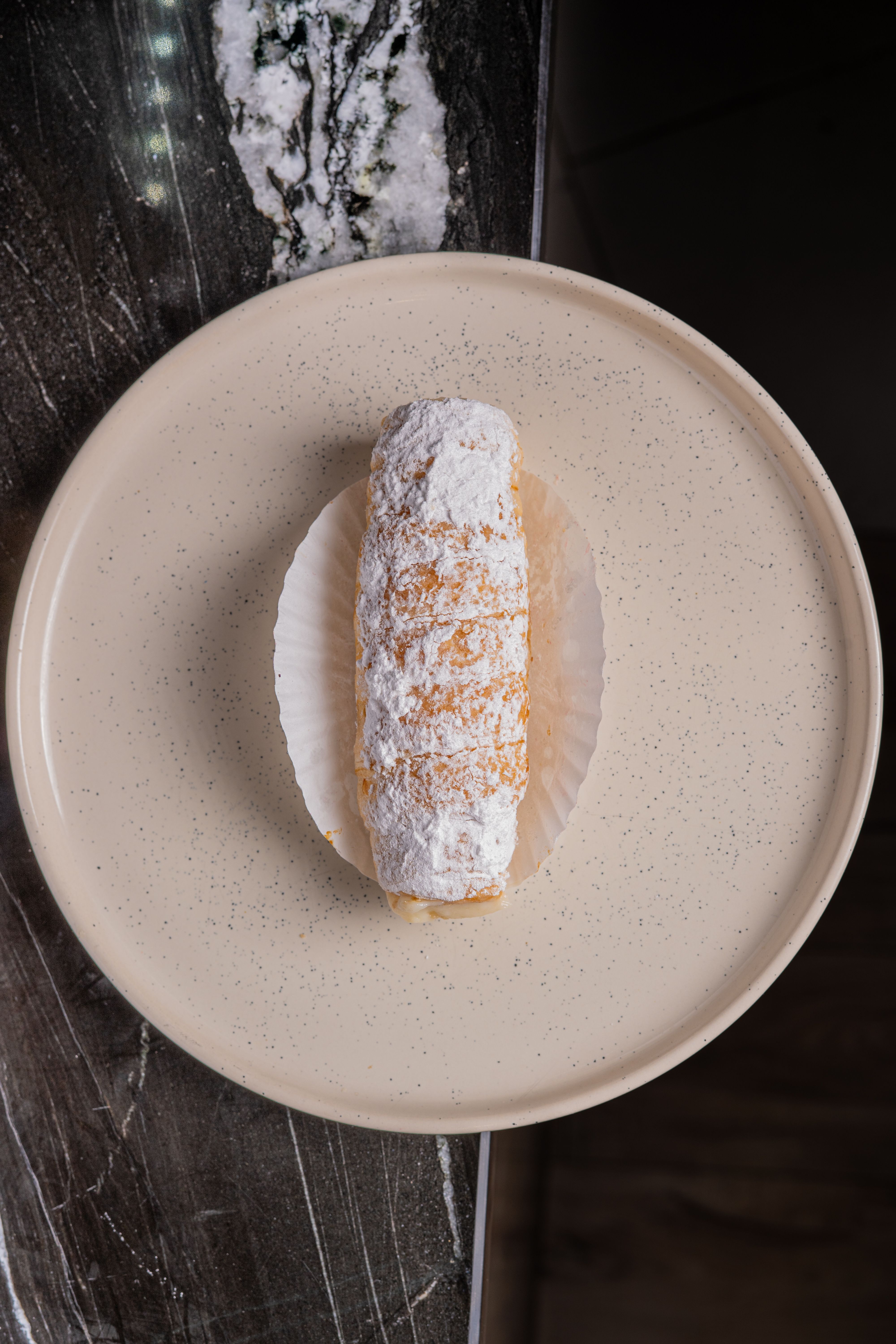 Delicious Cream-Filled Pastry with Powdered Sugar · Free Stock Photo