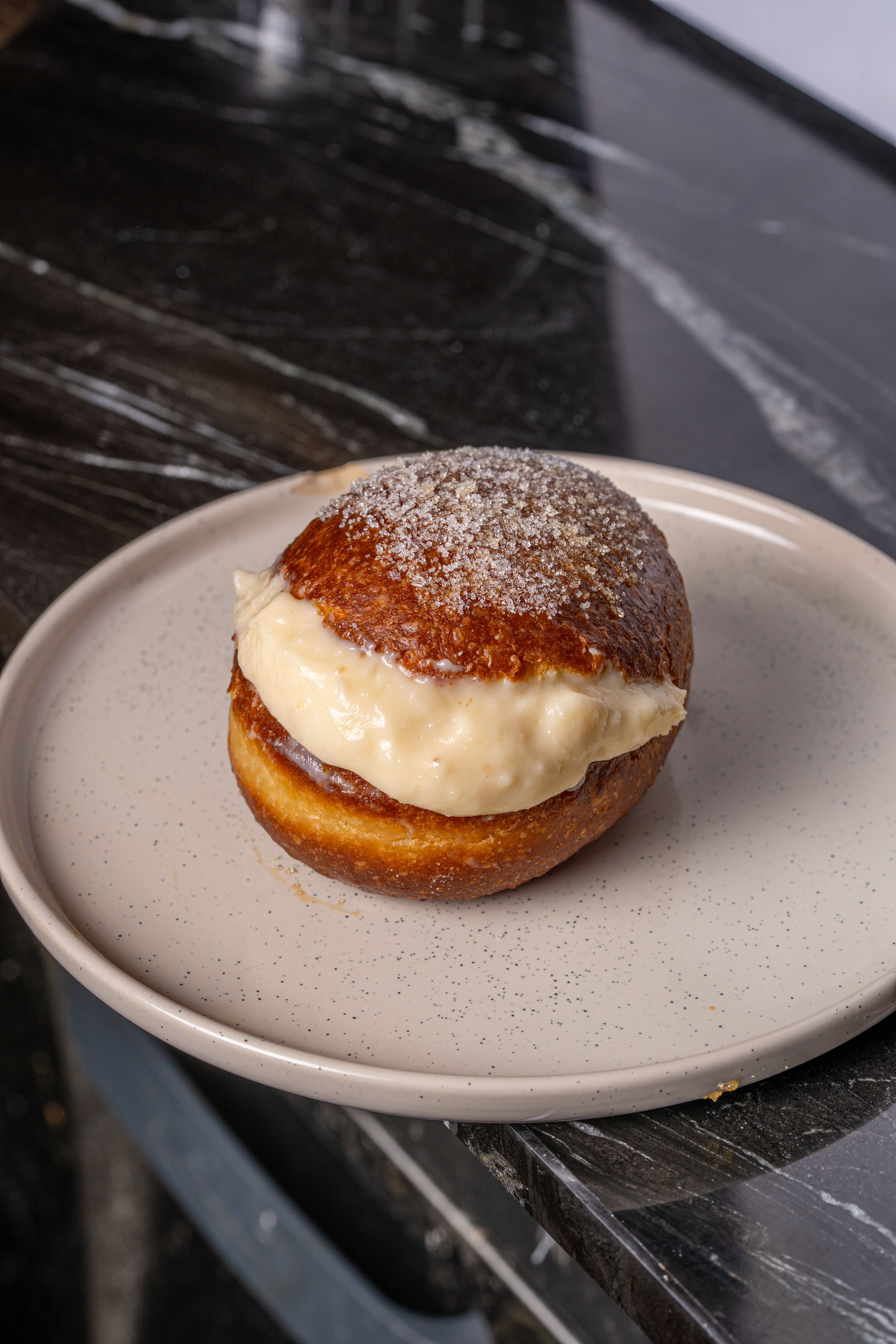 Delicious Cream-filled Powdered Doughnut on Plate · Free Stock Photo