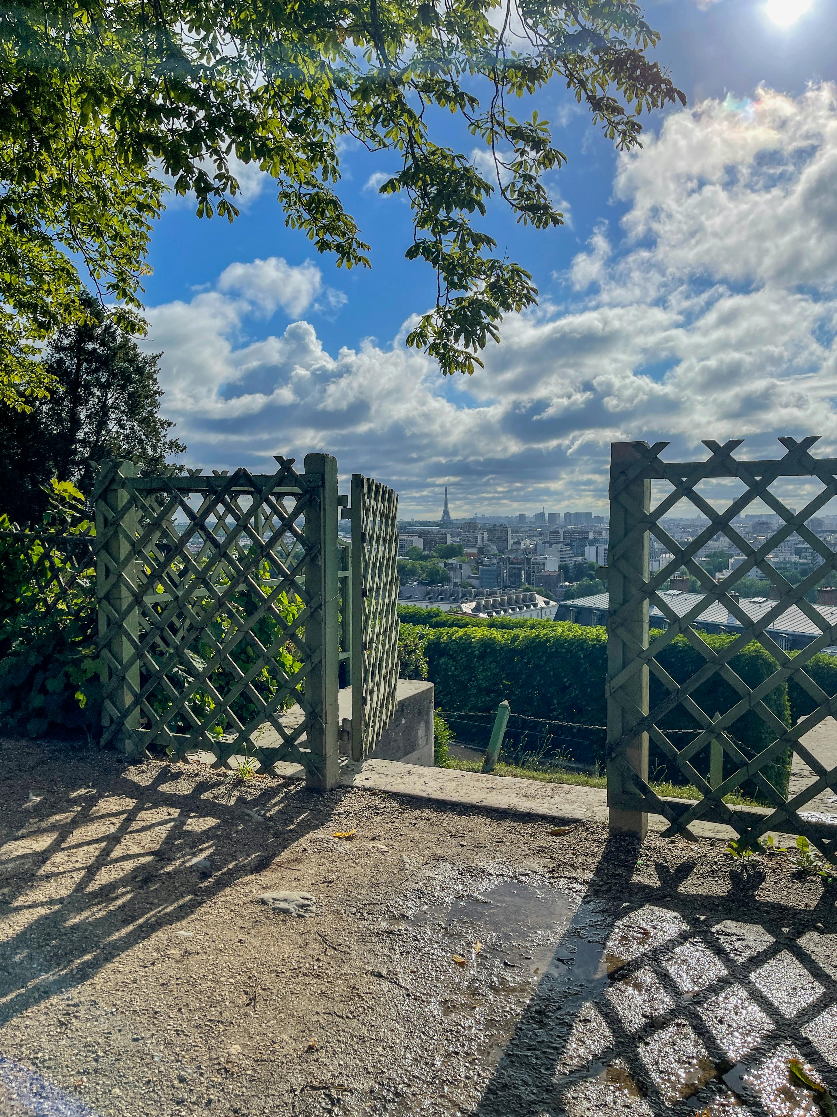 Garden Gate Overlooking Paris Skyline with Eiffel Tower · Free Stock Photo
