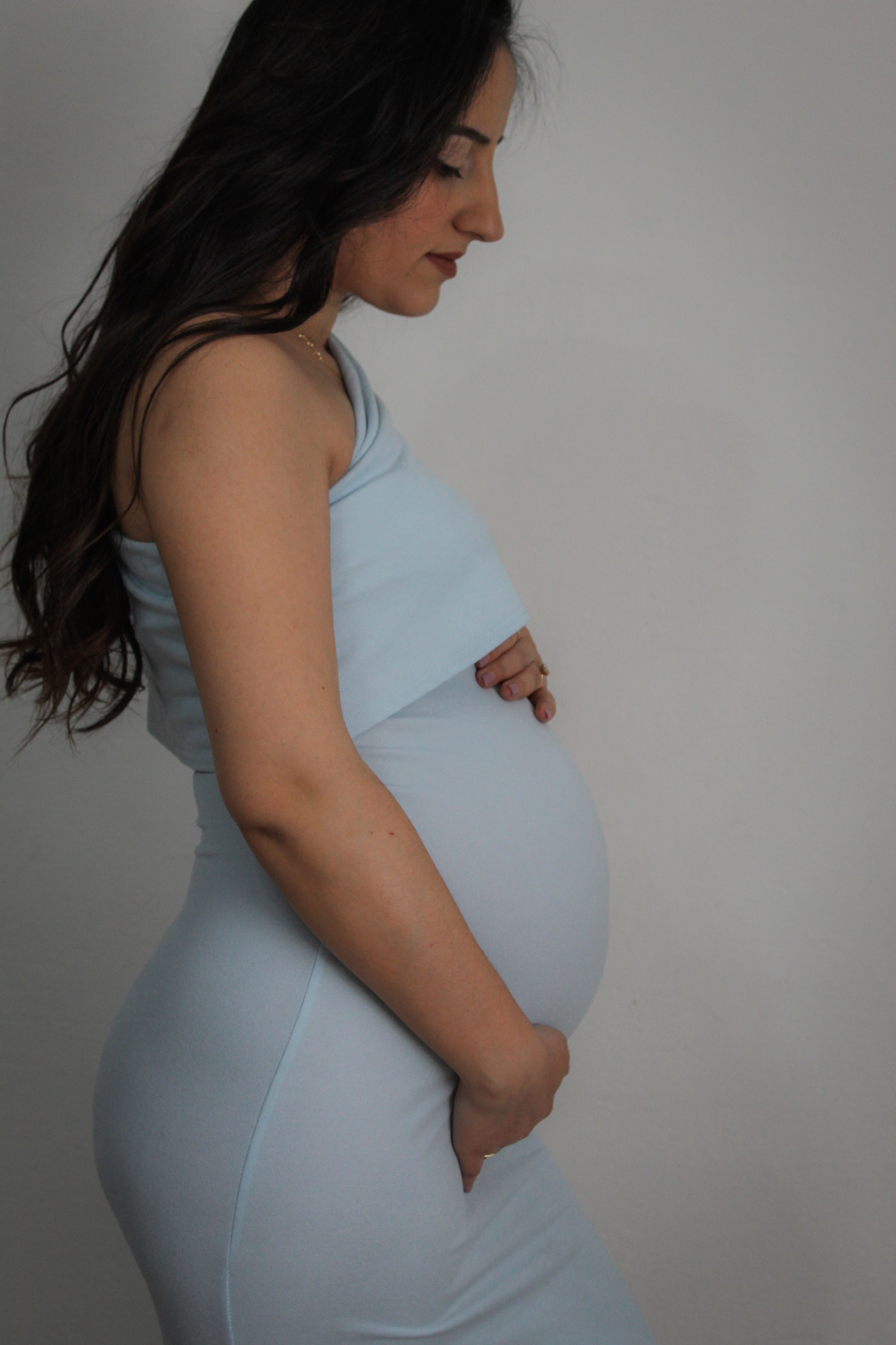 Elegant Maternity Portrait in Soft Lighting · Free Stock Photo