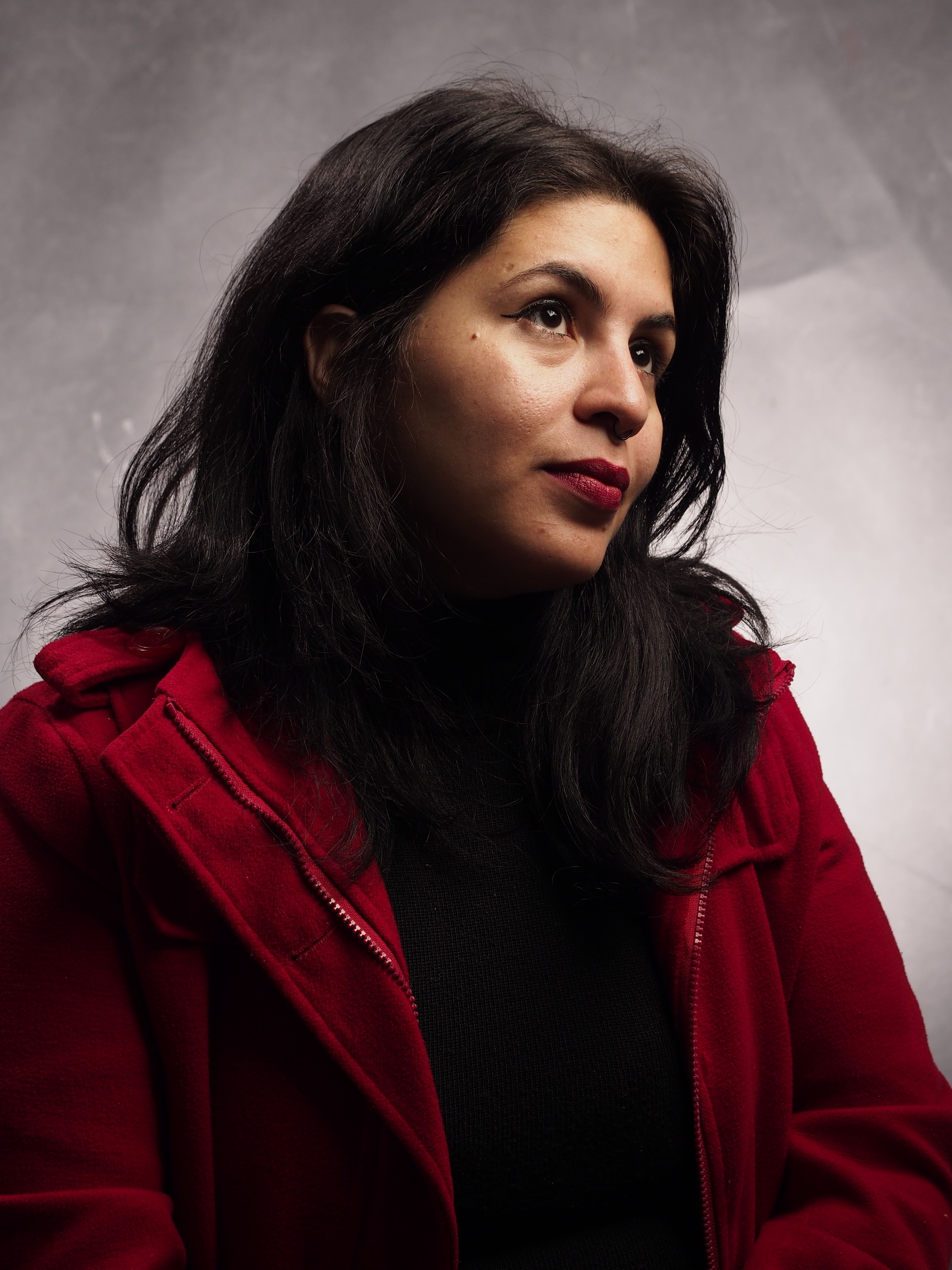 Portrait of Woman in Red Coat Looking Thoughtful · Free Stock Photo