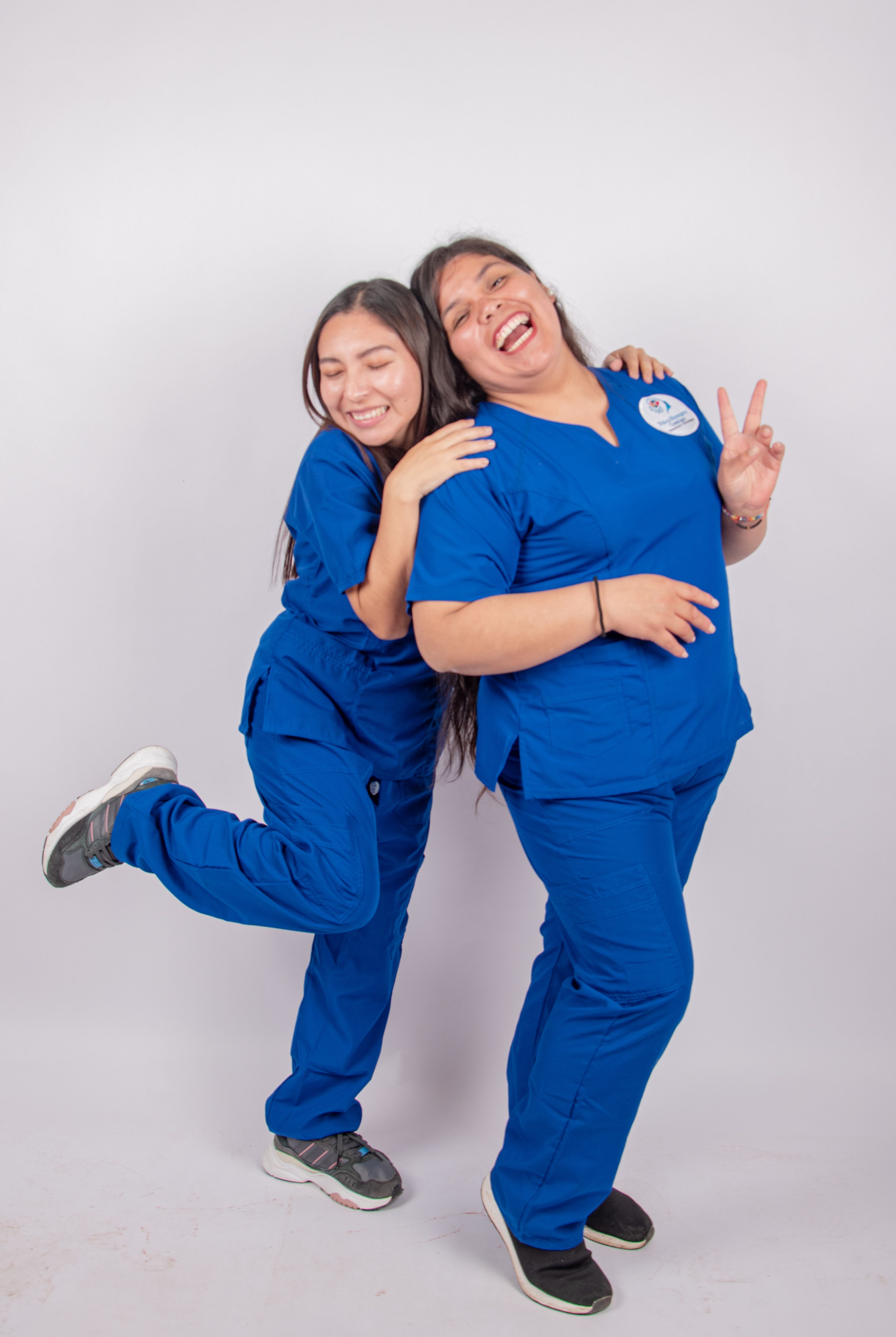 Joyful Nurses Posing in Blue Scrubs · Free Stock Photo