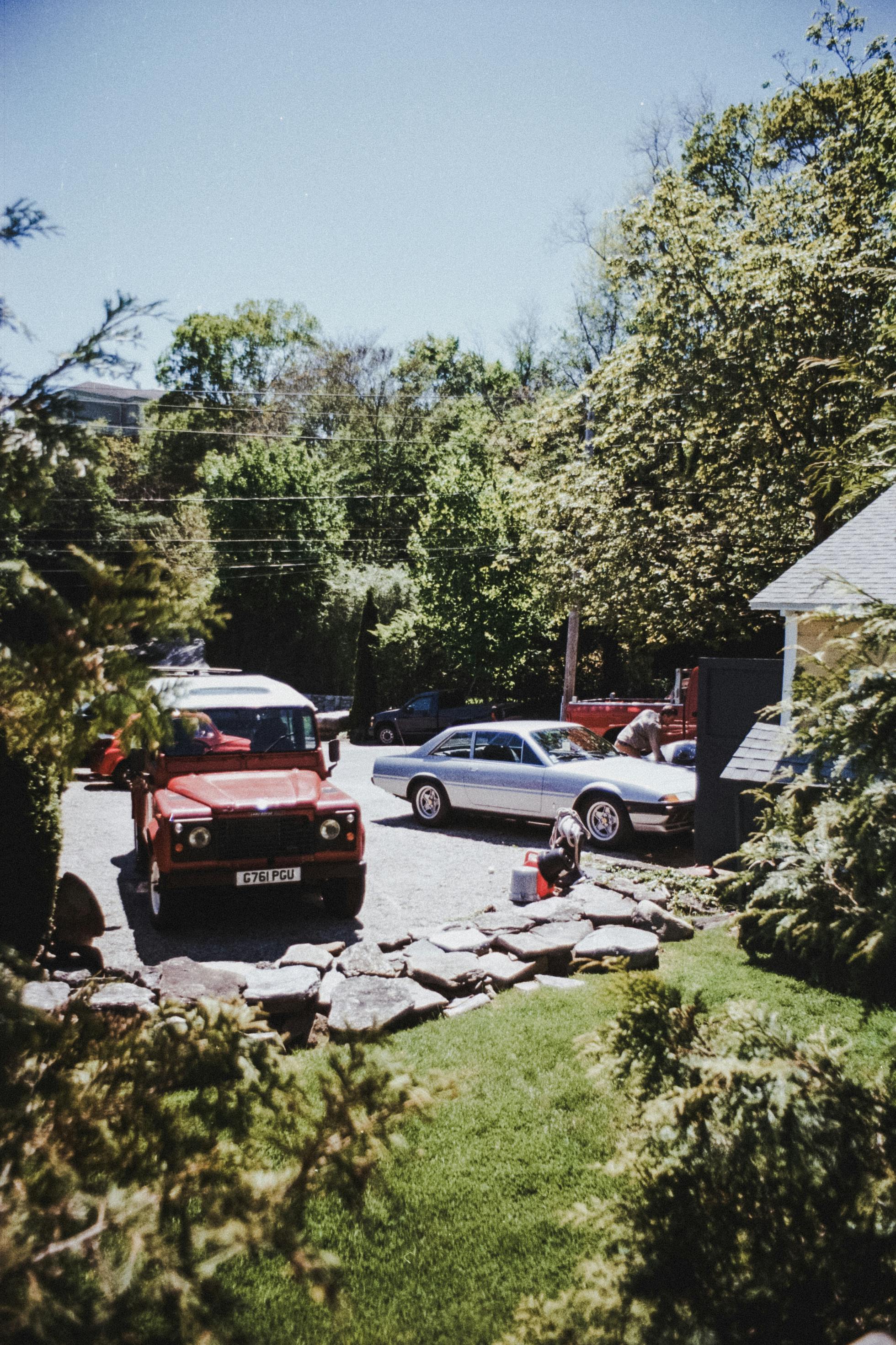 Classic Cars in Sunny Backyard Setting · Free Stock Photo