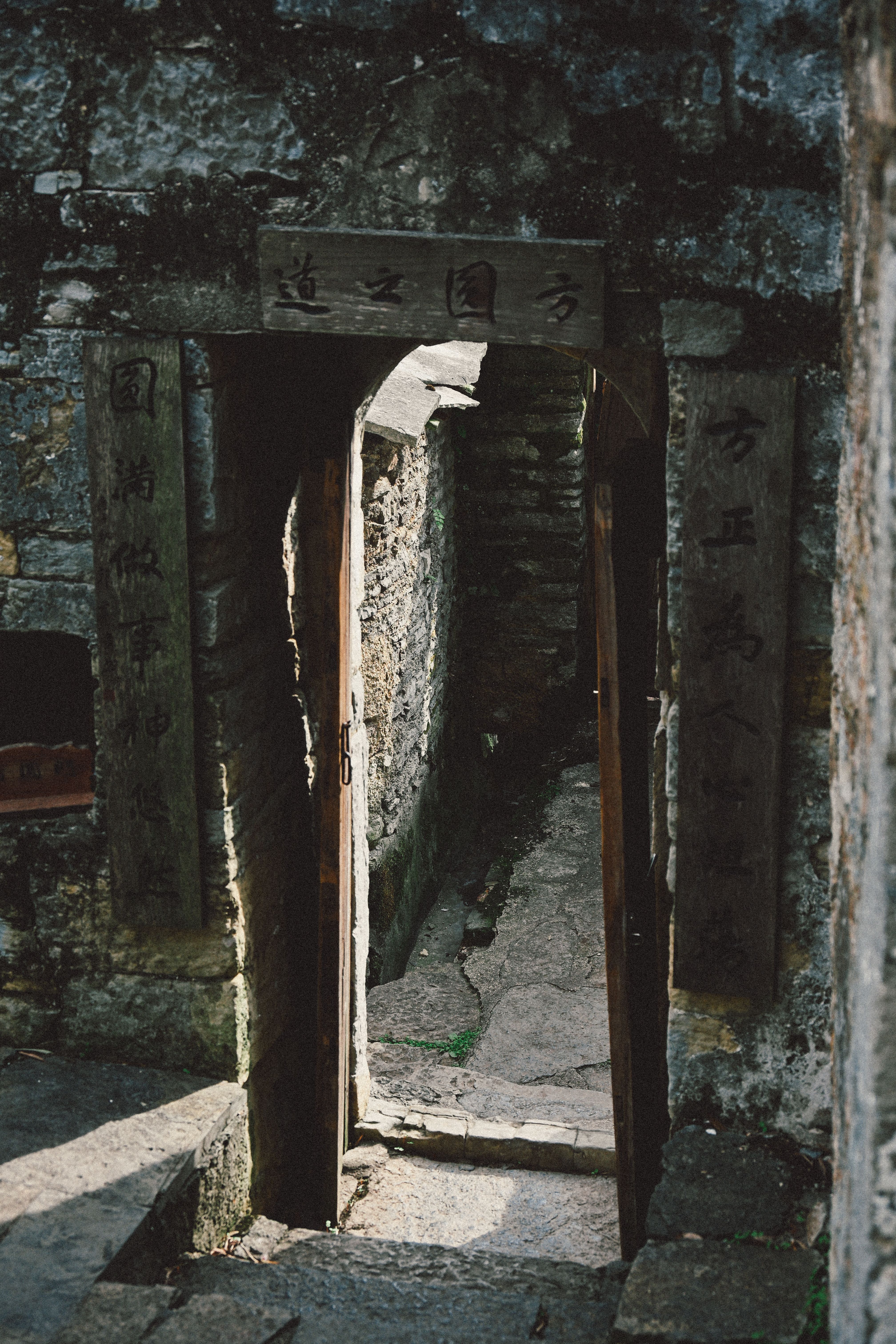 Ancient Stone Archway with Carved Inscriptions · Free Stock Photo