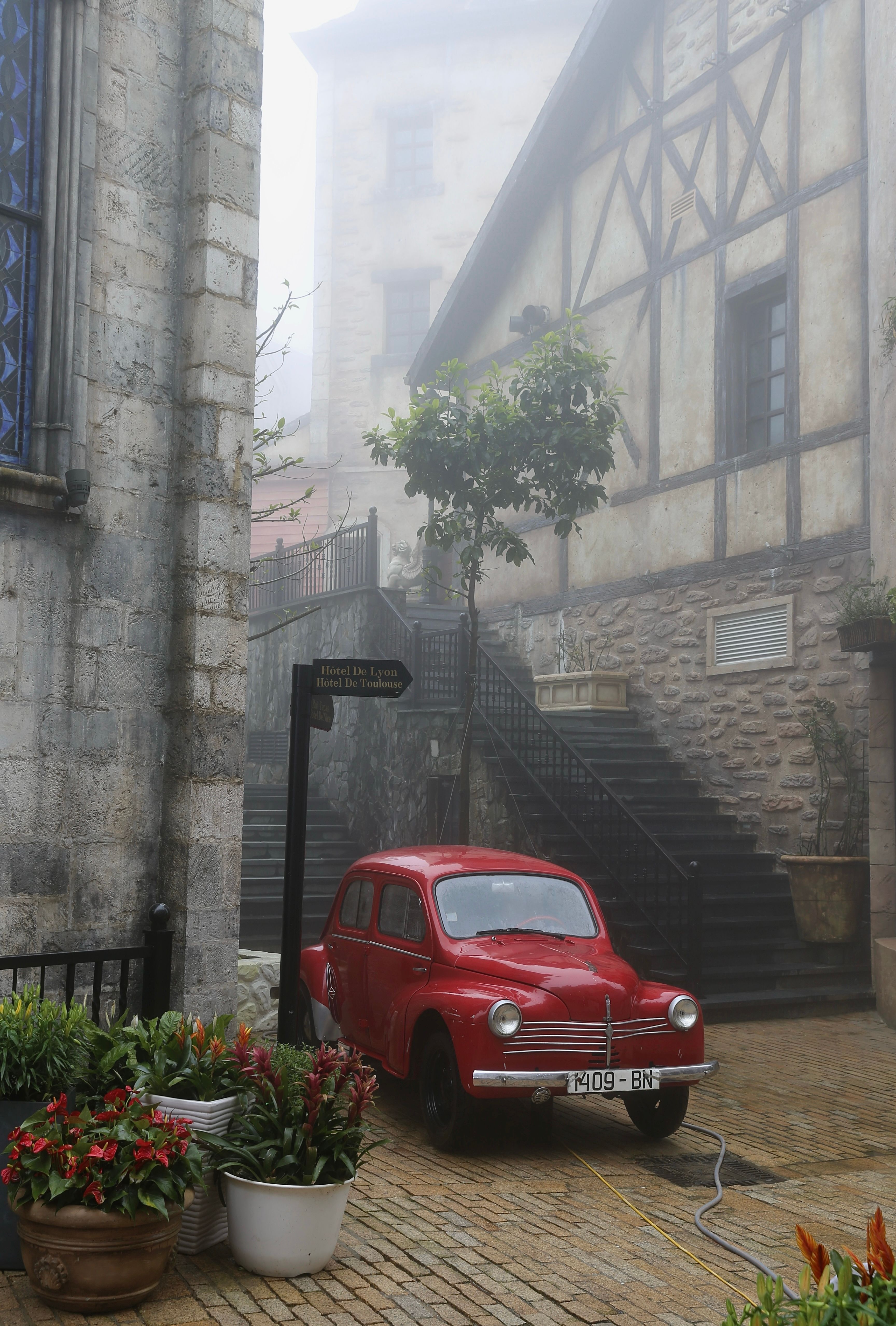 Charming European Alley with Classic Red Car · Free Stock Photo