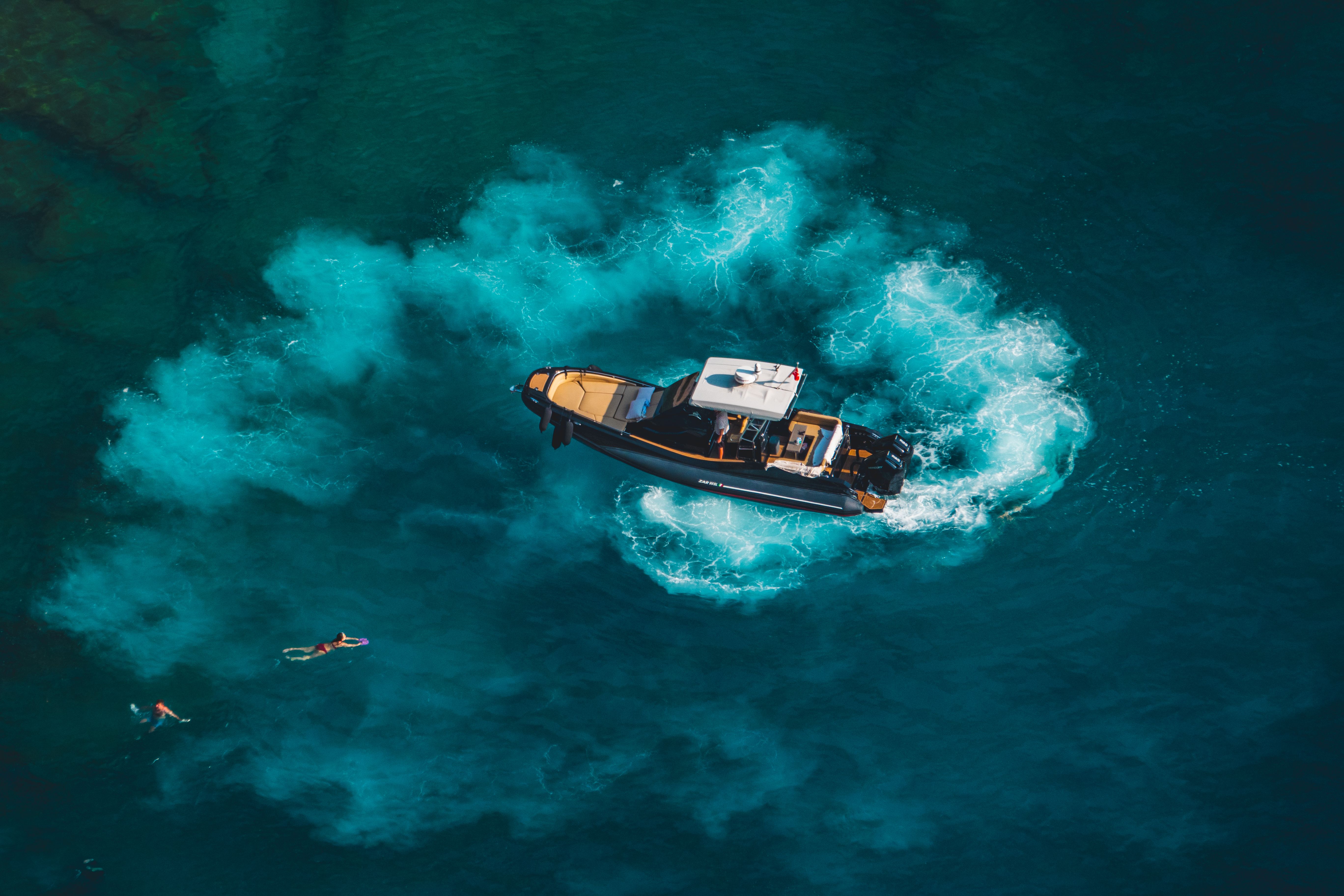 Top View Photo of Boat on Ocean · Free Stock Photo