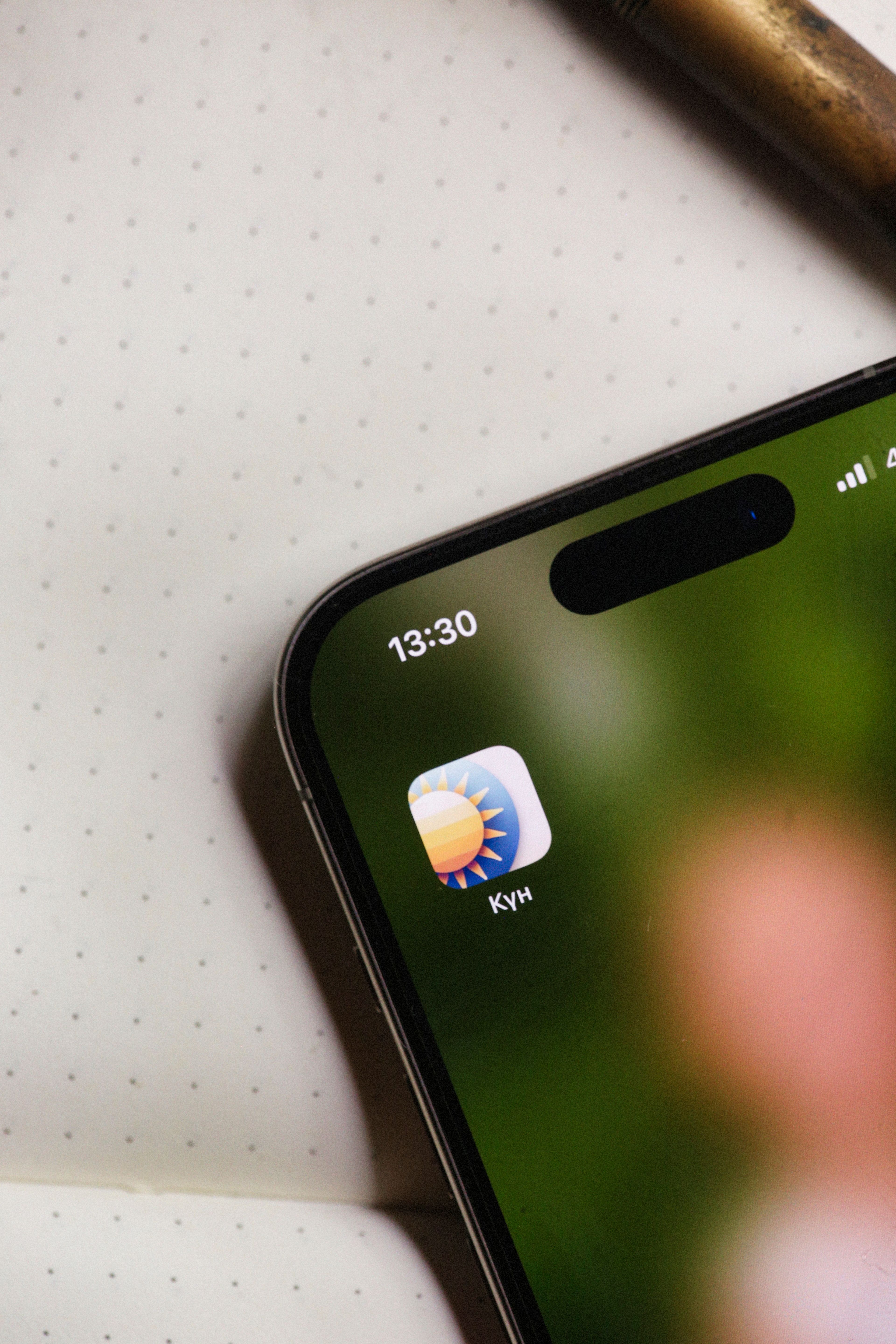 Holding a Smartphone in front of an Imac · Free Stock Photo