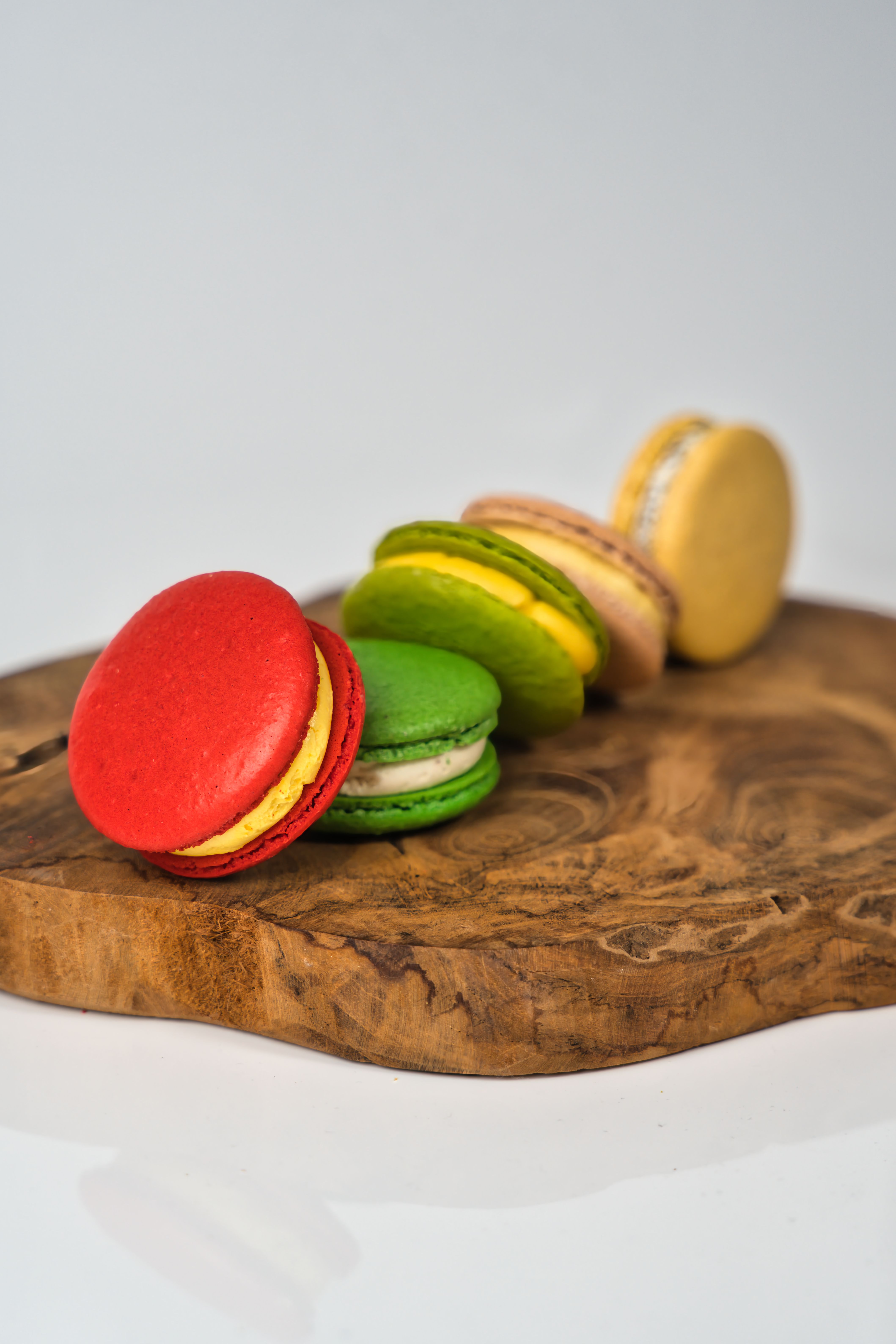 Colorful French Macarons on Wooden Platter · Free Stock Photo
