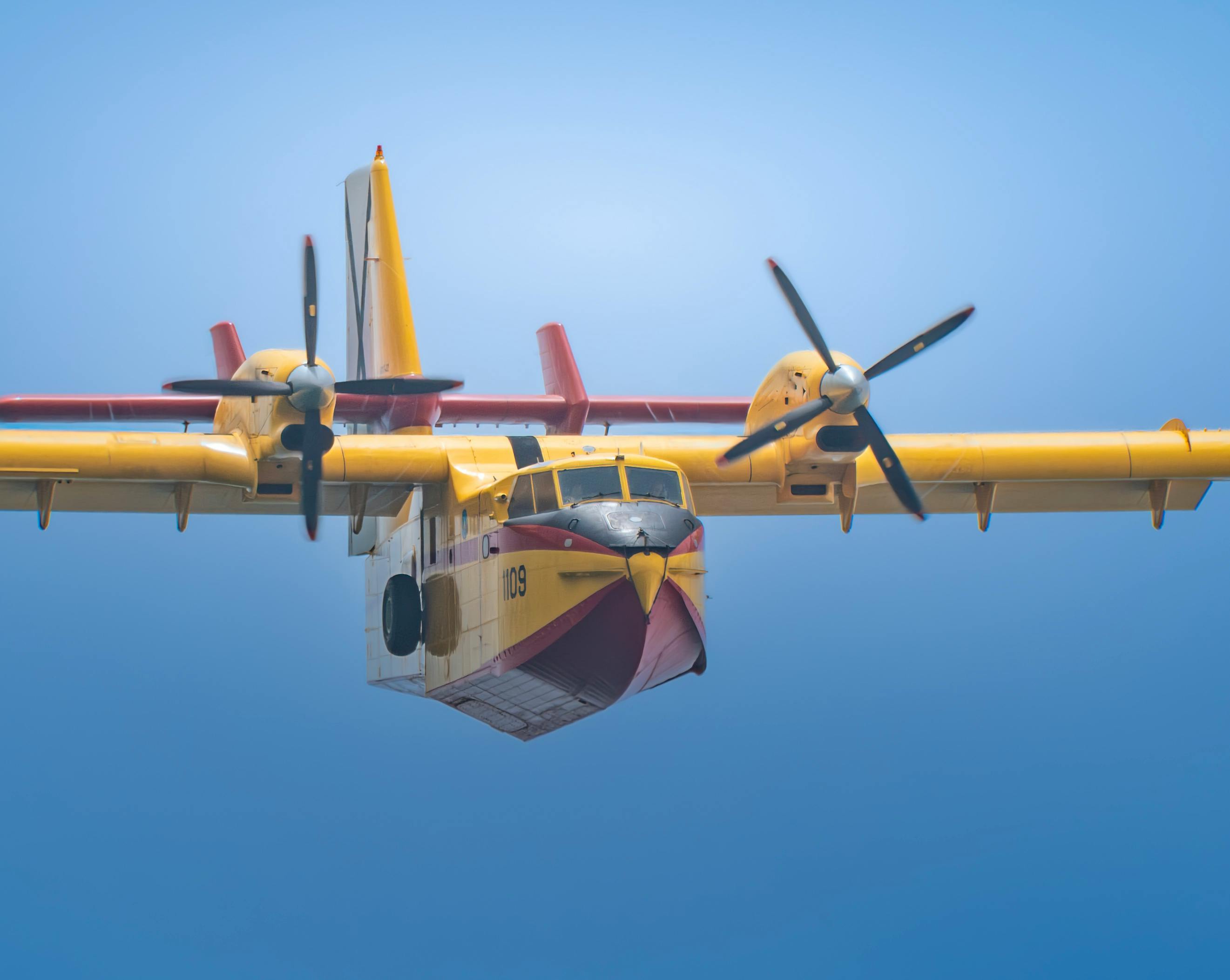 Yellow and Red Firefighting Plane in Flight · Free Stock Photo