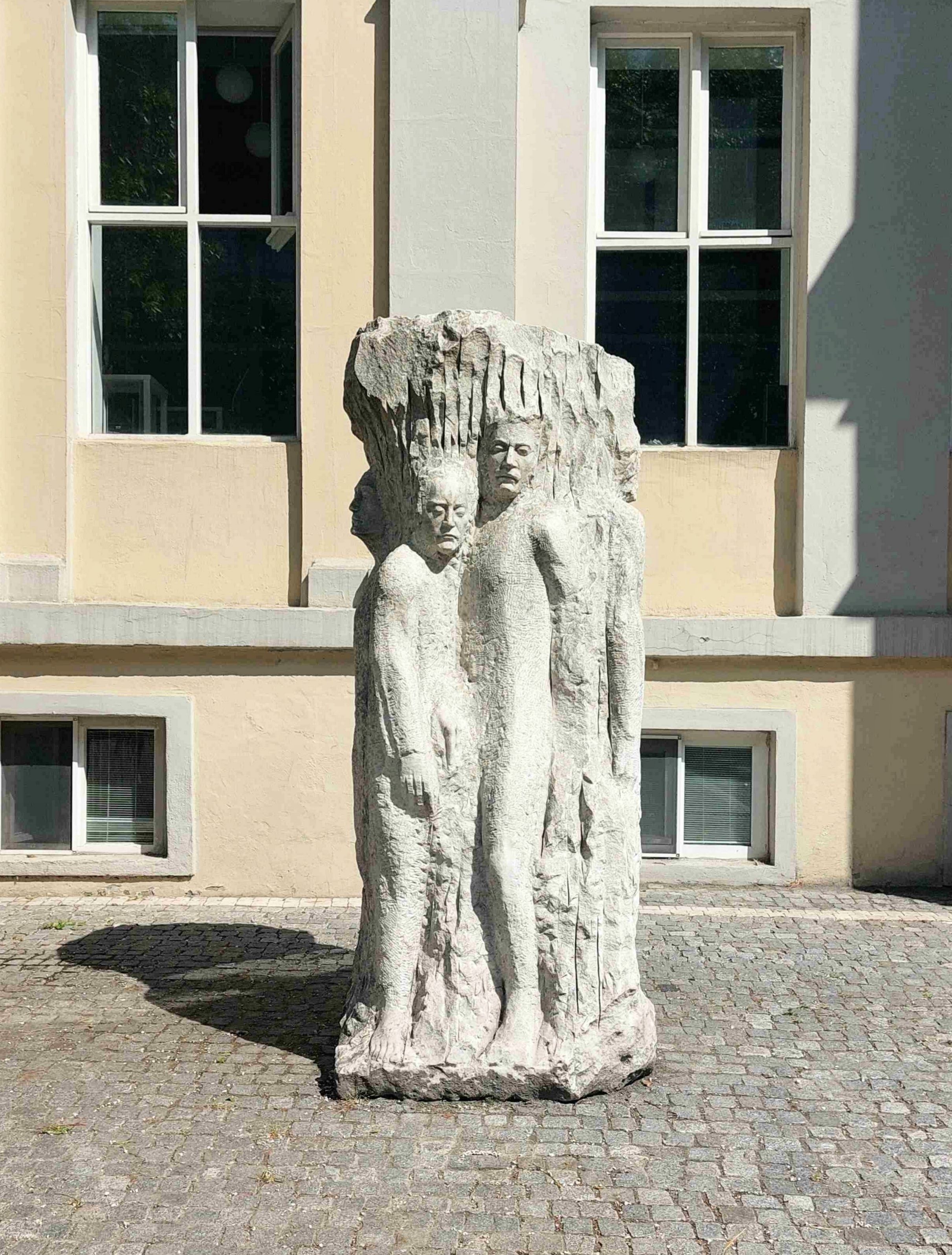 Stone sculpture with human forms outdoors · Free Stock Photo