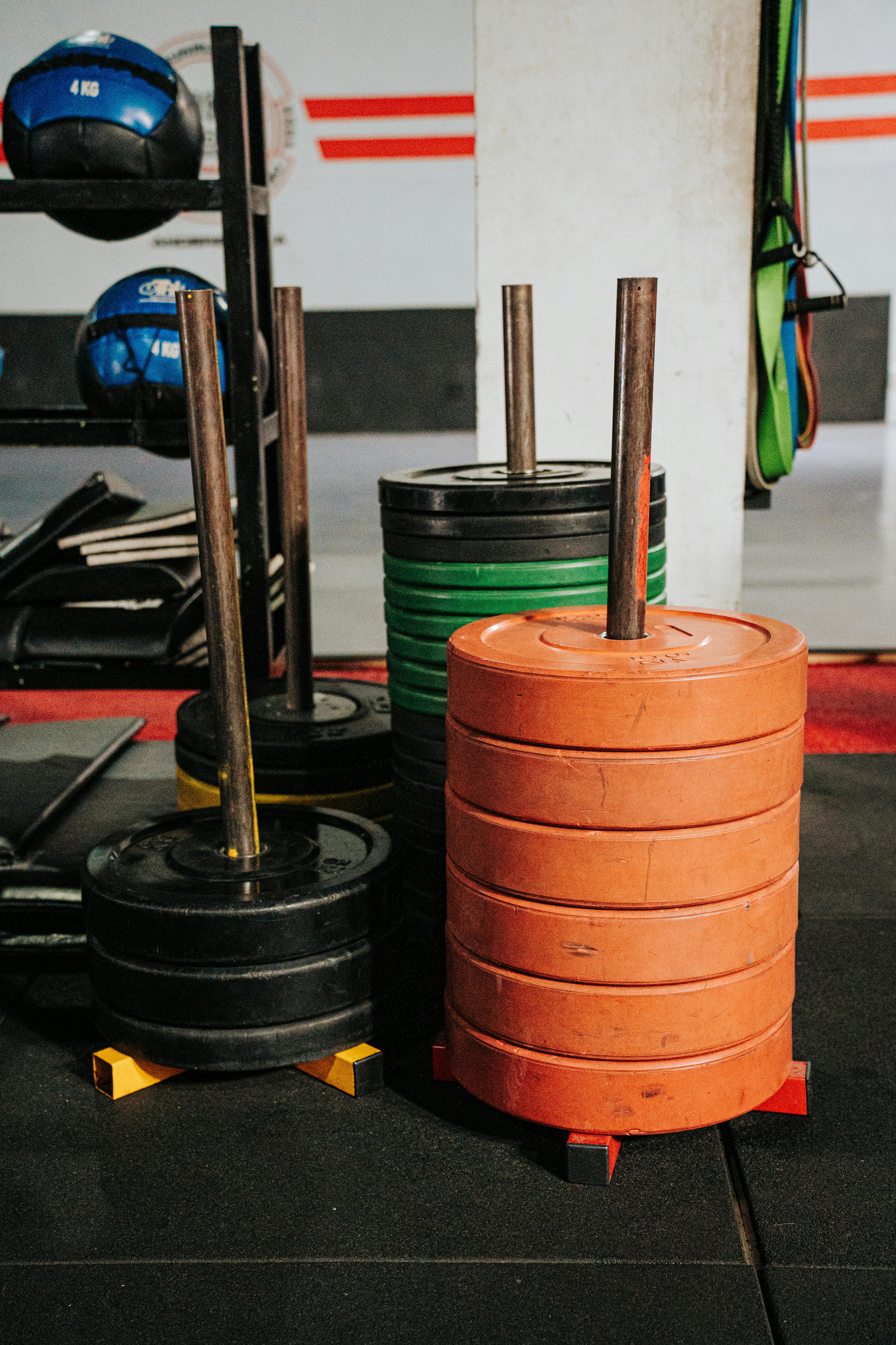 Colorful Weight Plates in an Indoor Gym Setting · Free Stock Photo